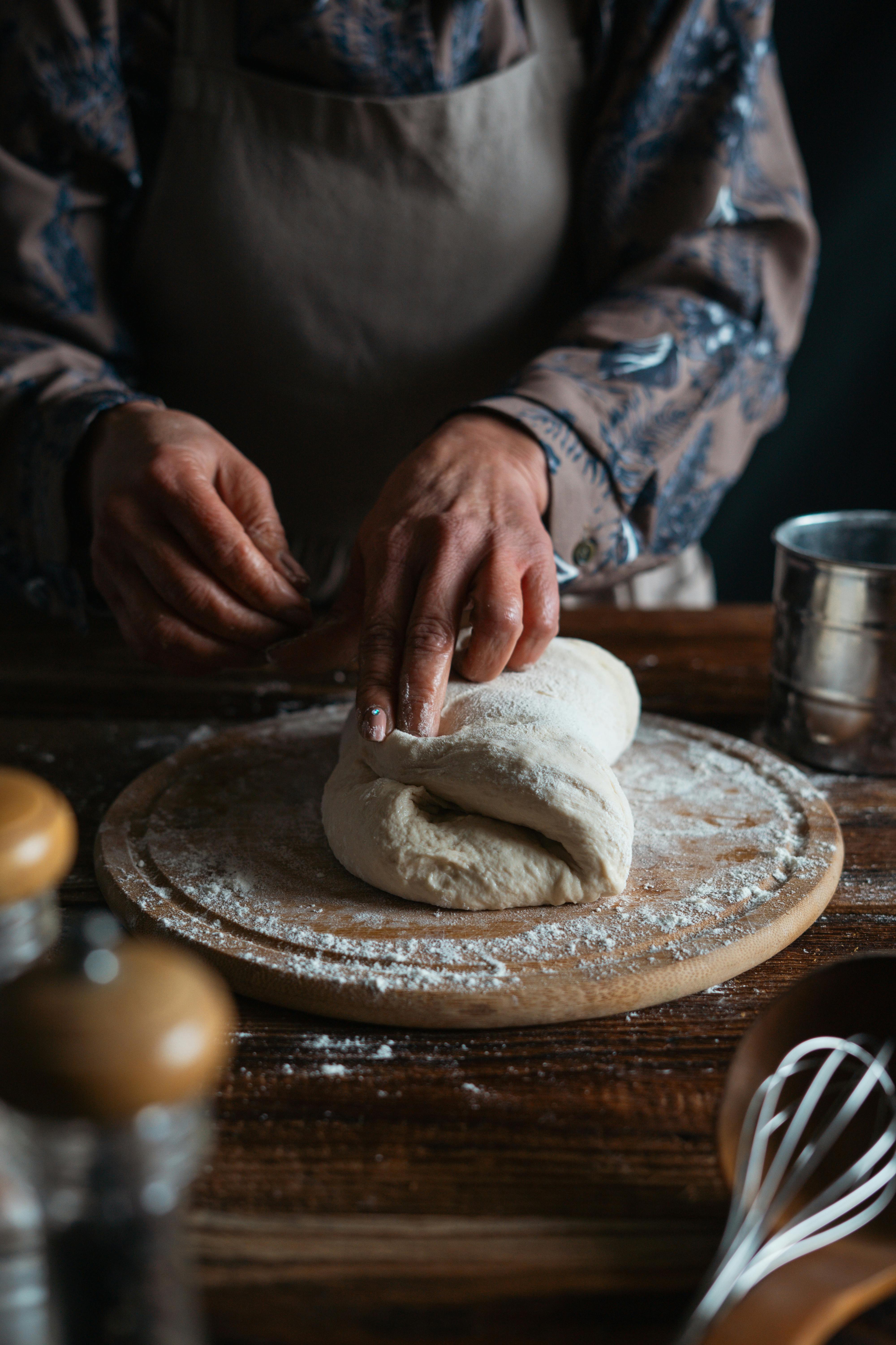 Baker Kneading Dough on Wooden Surface · Free Stock Photo