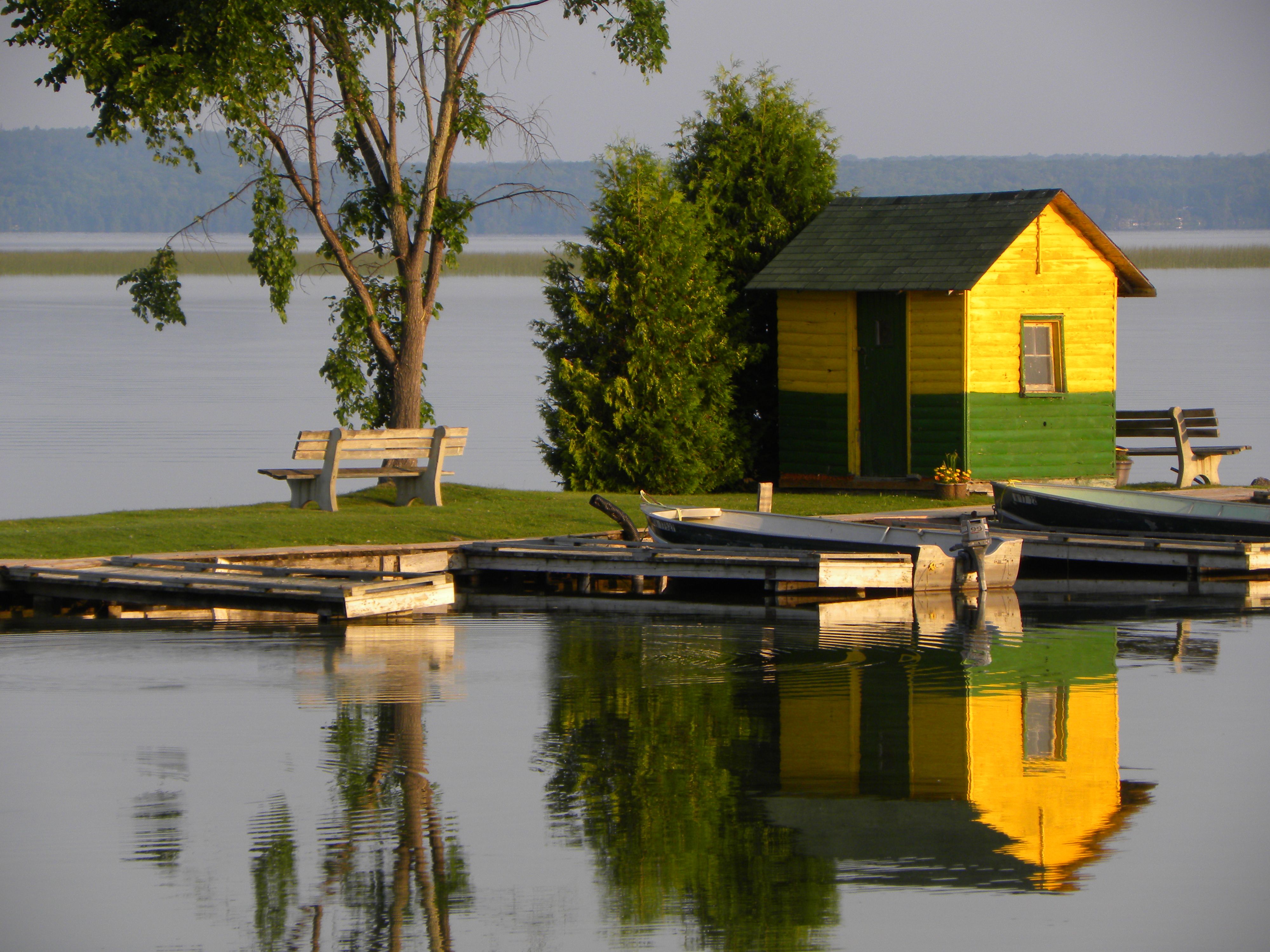 Tranquil Lakeside Dock and Colorful Hut · Free Stock Photo