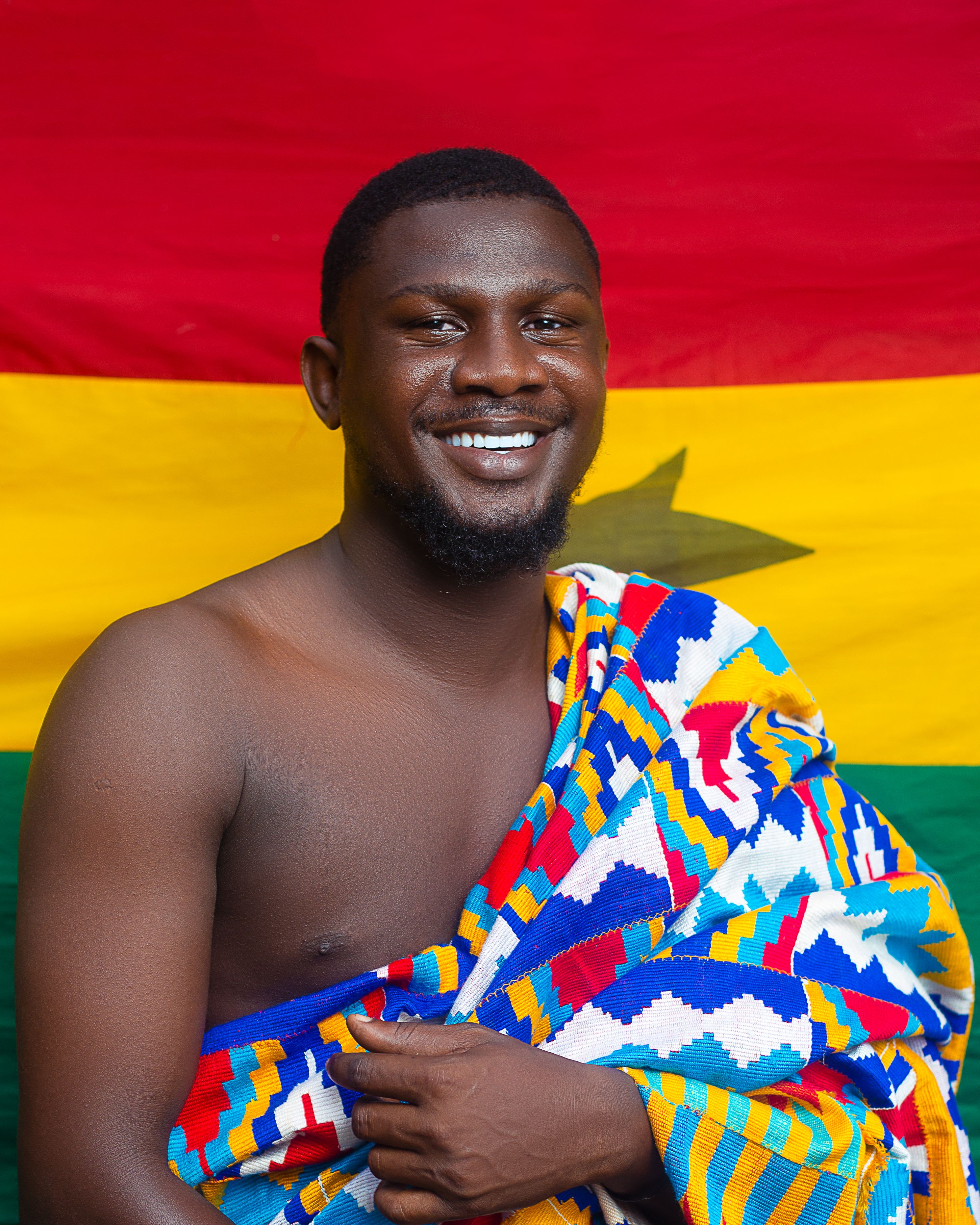 Portrait of a Smiling Man in Traditional Ghanaian Attire · Free Stock Photo