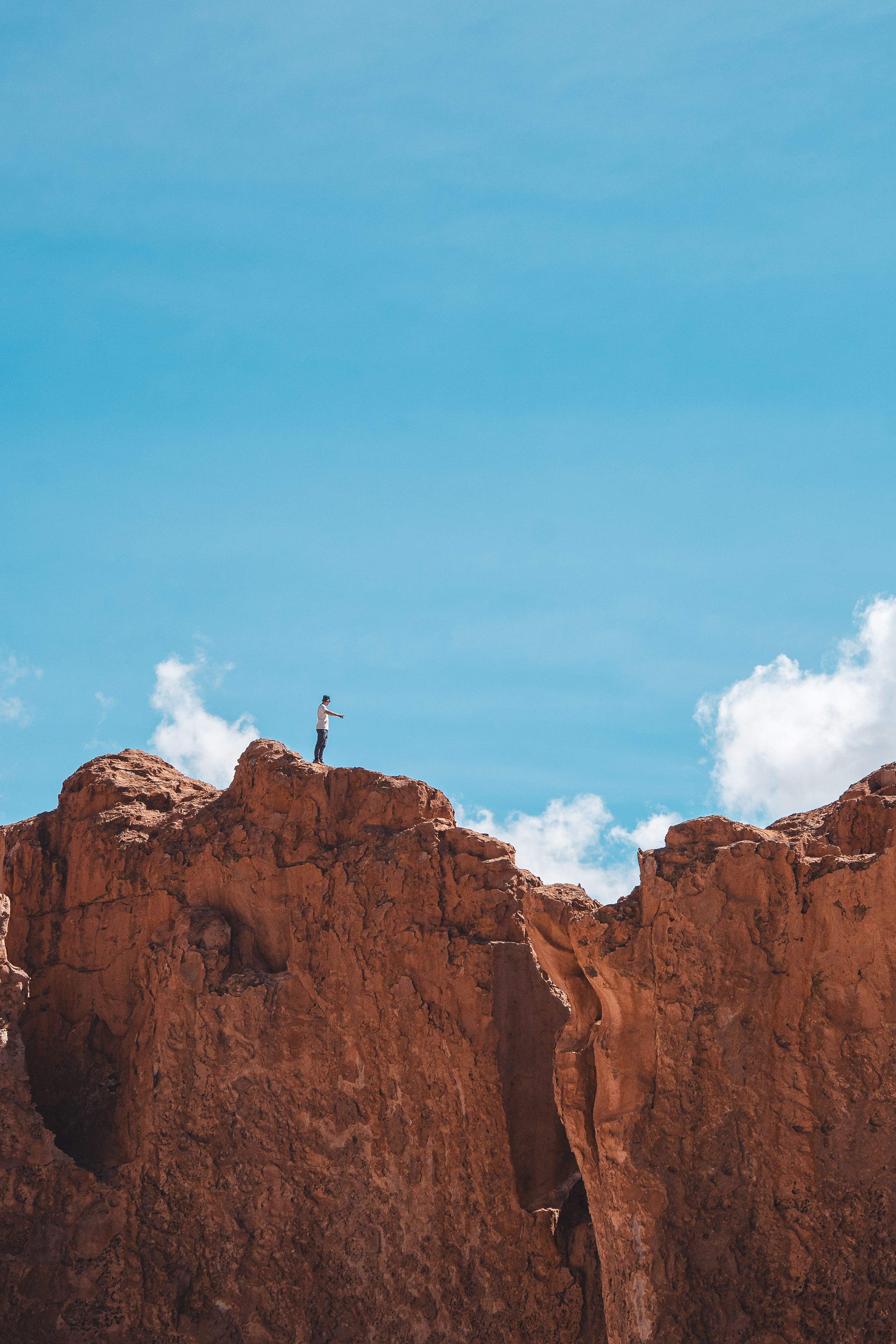 Lone Adventurer on Jagged Cliff in Bolivia · Free Stock Photo