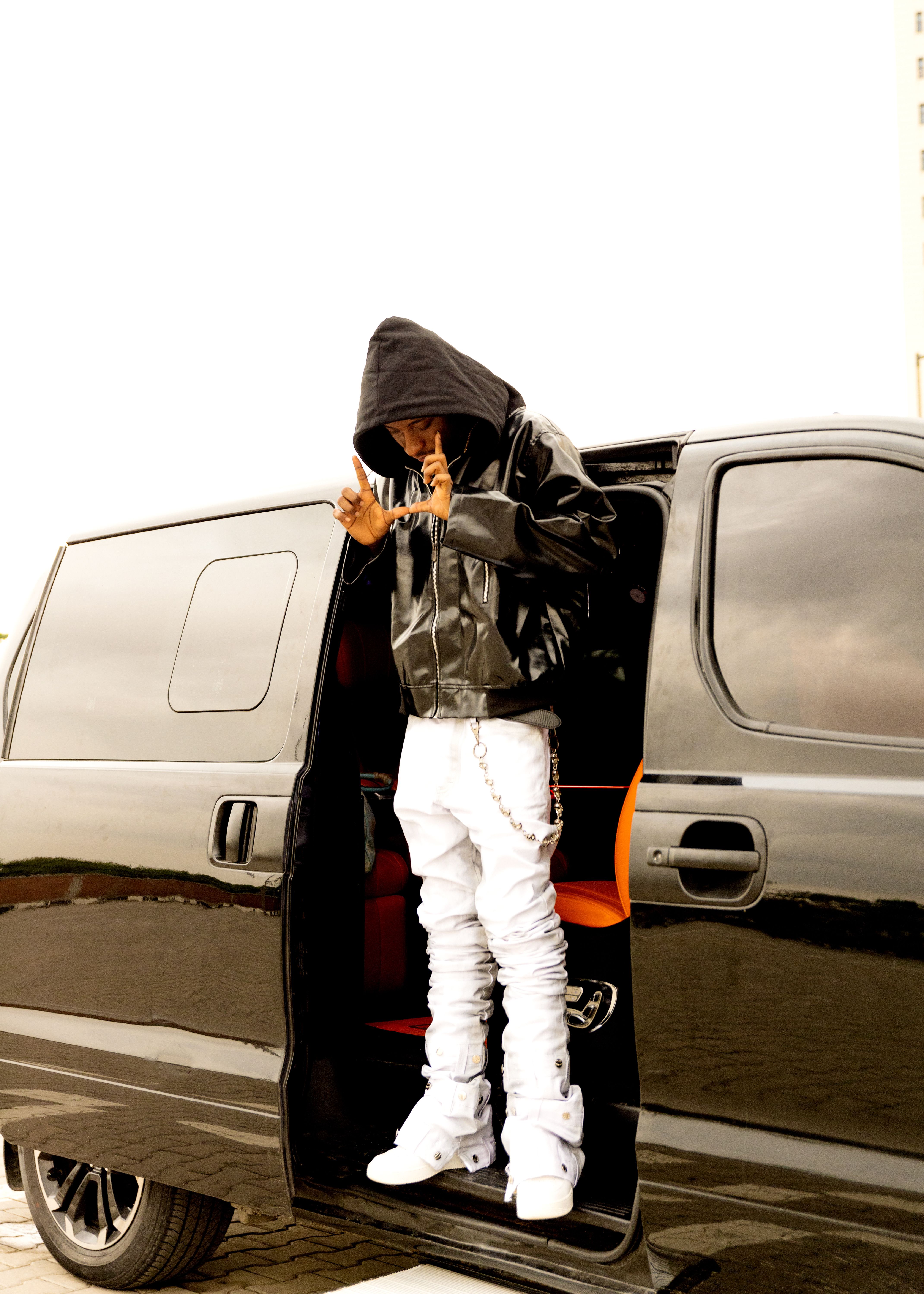 Stylish Individual Exiting Black Luxury Van · Free Stock Photo