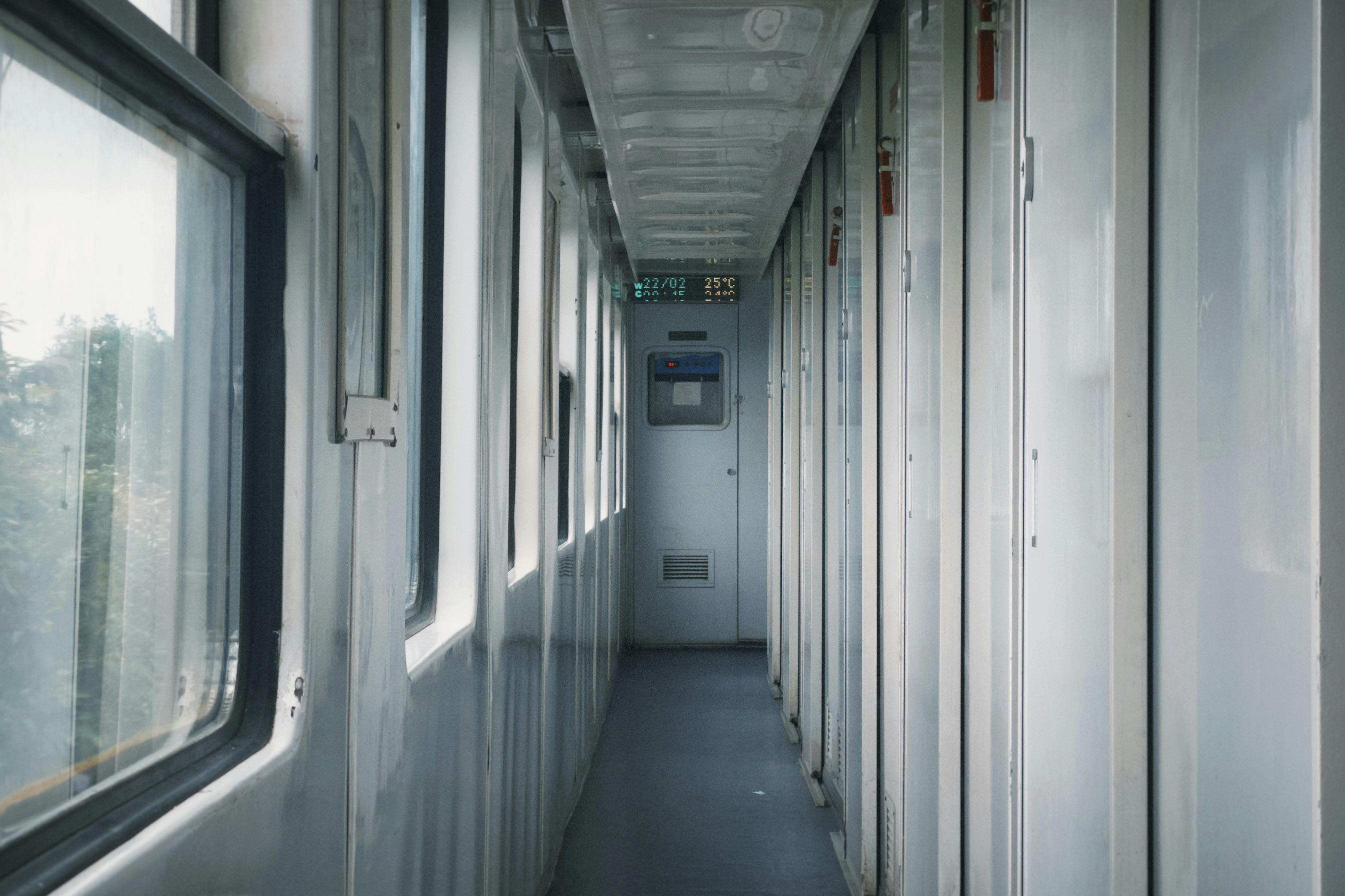 Narrow Train Corridor with Doors and Windows · Free Stock Photo
