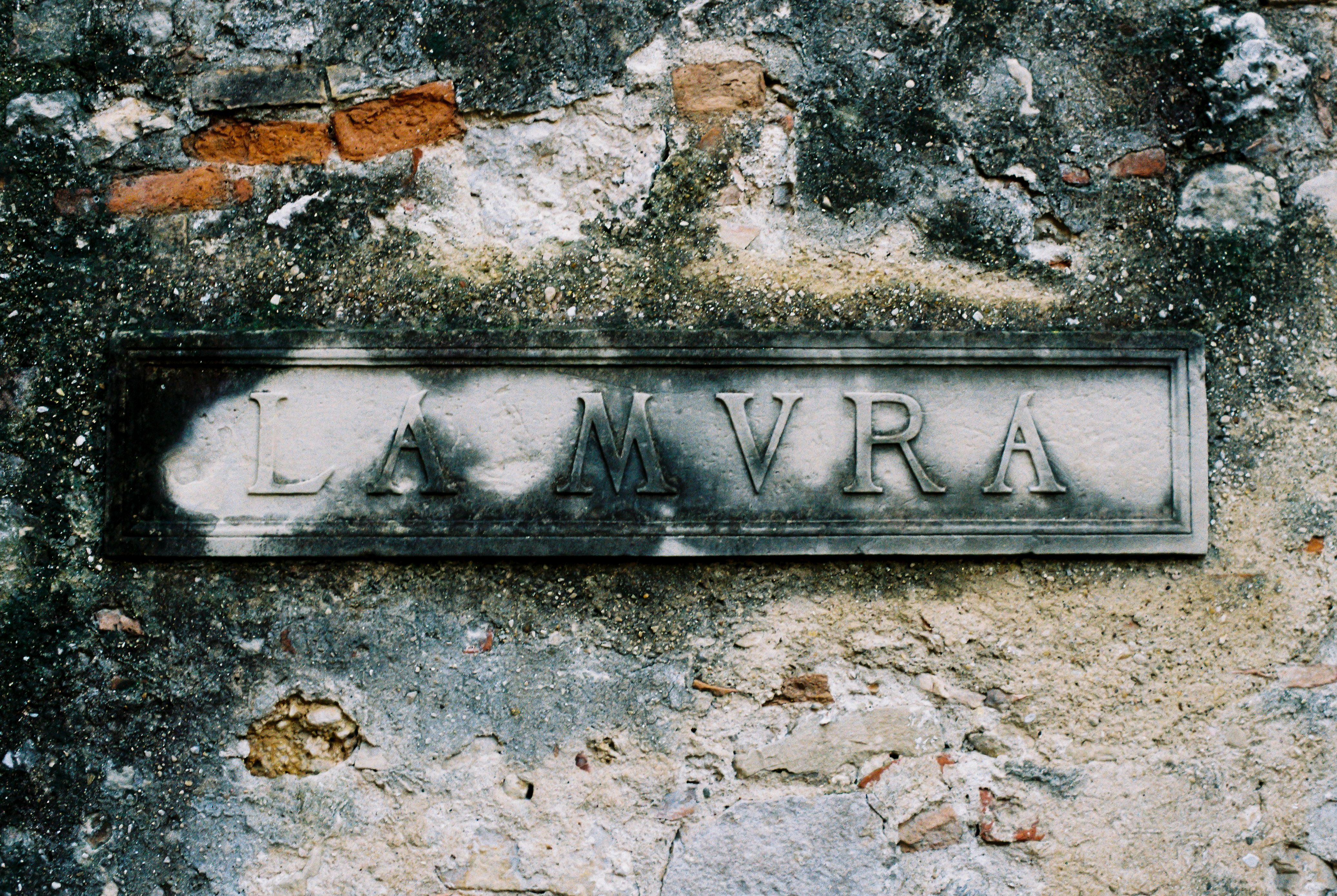 Weathered Stone Sign on Rustic Wall Outdoors · Free Stock Photo