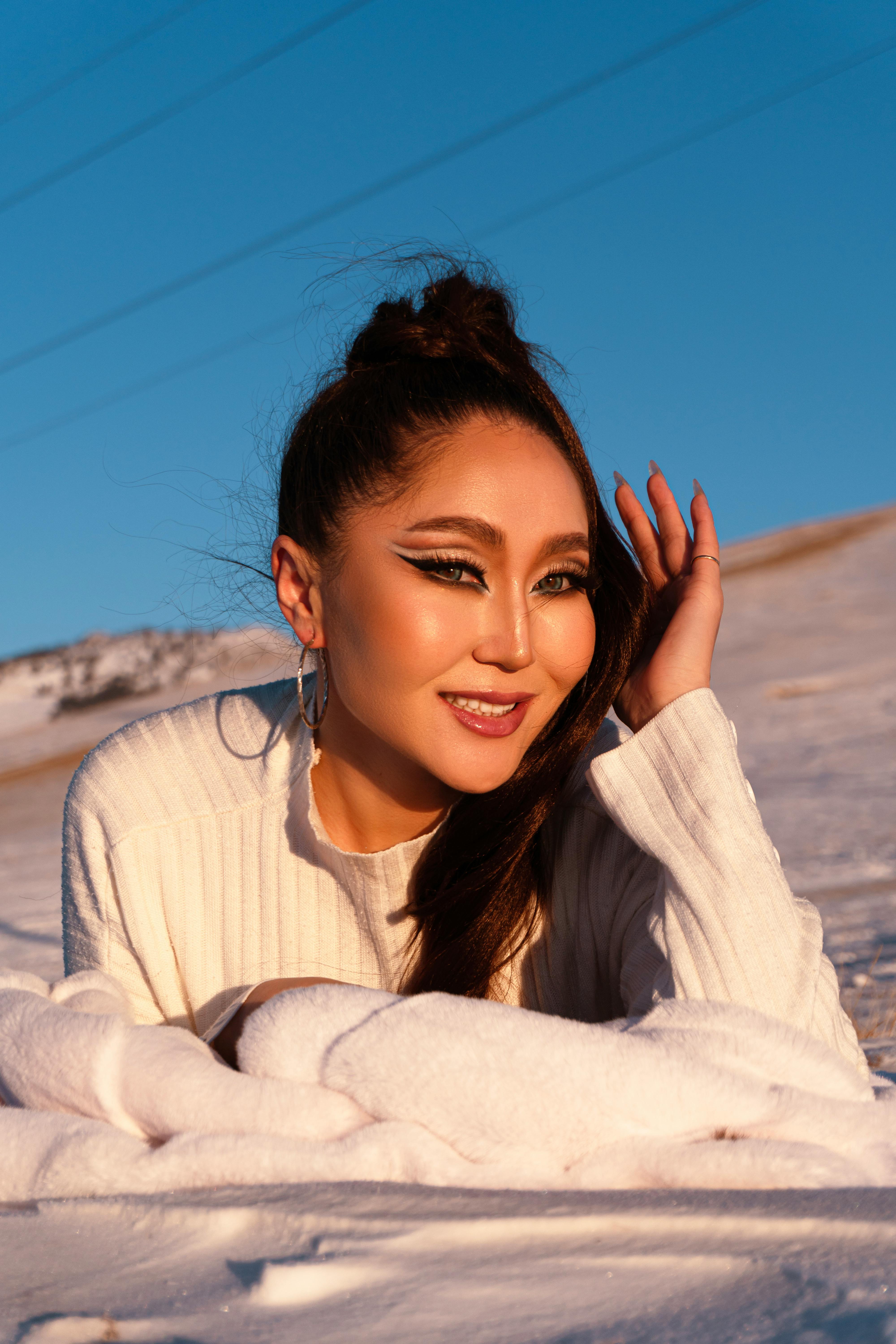 Woman in Winter Landscape Smiling at Sunset · Free Stock Photo
