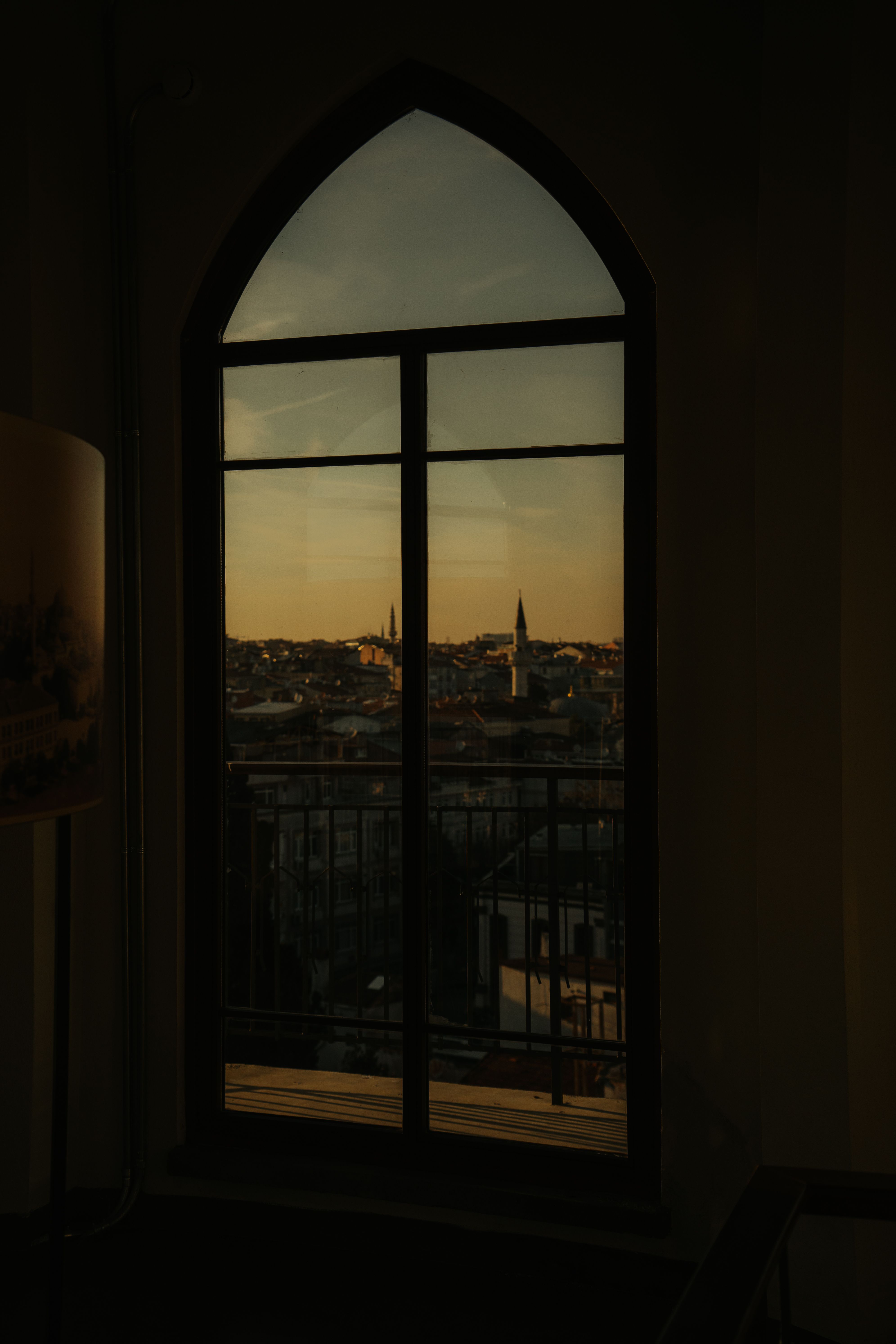 Cityscape at Sunset Through Gothic Window · Free Stock Photo