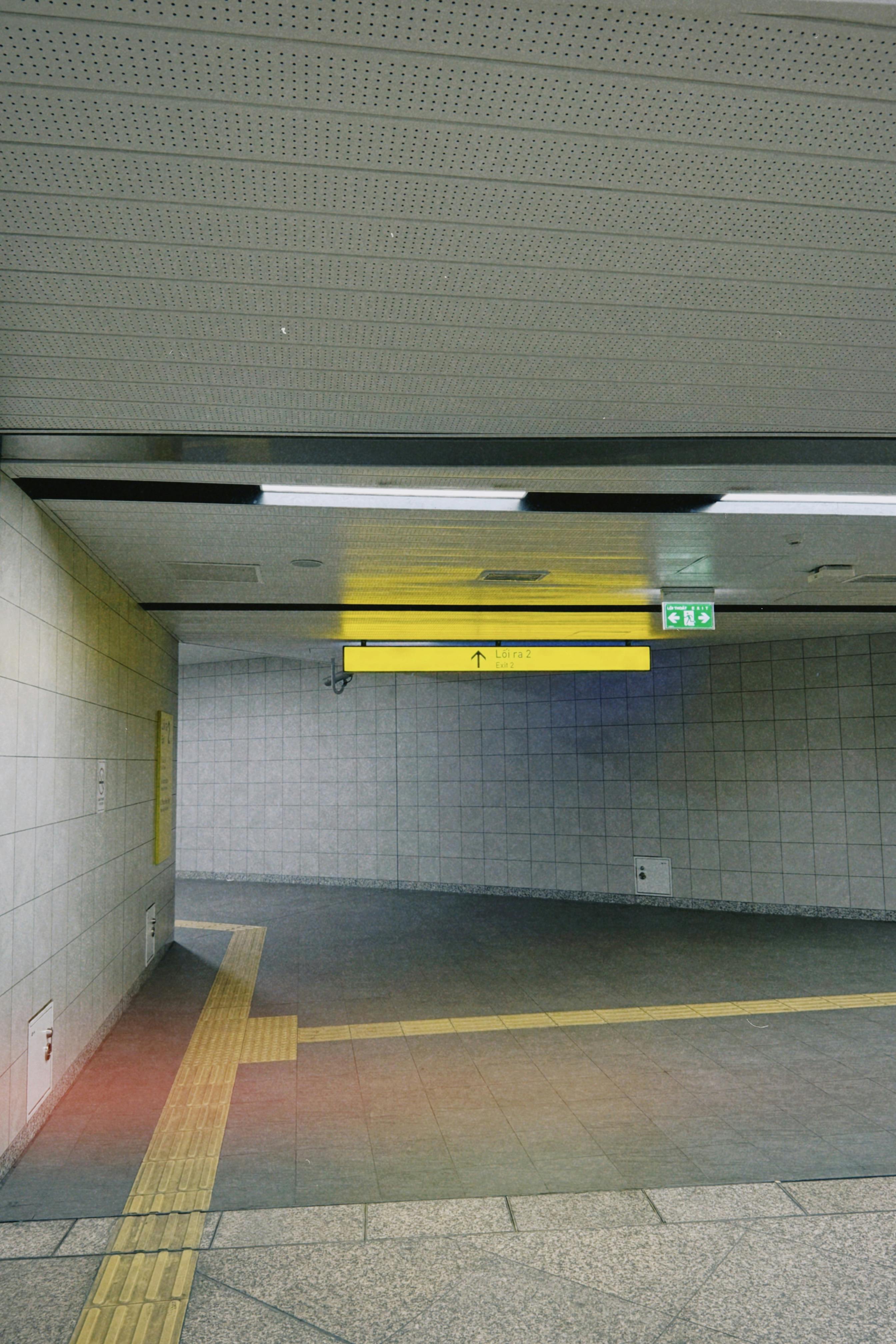 Subway Exit Corridor with Yellow Signage · Free Stock Photo