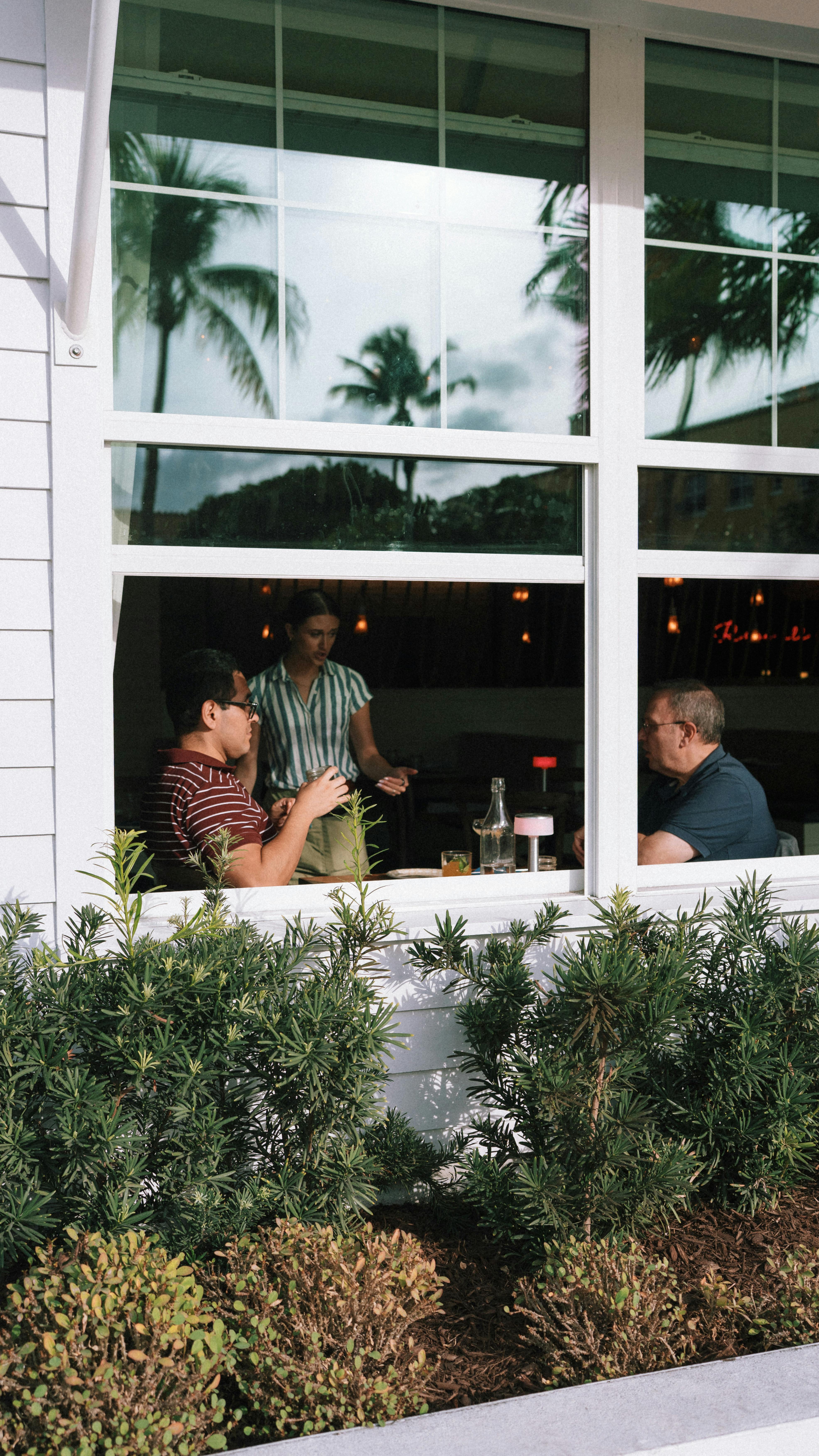 Casual Dining Scene Viewed Through Window · Free Stock Photo