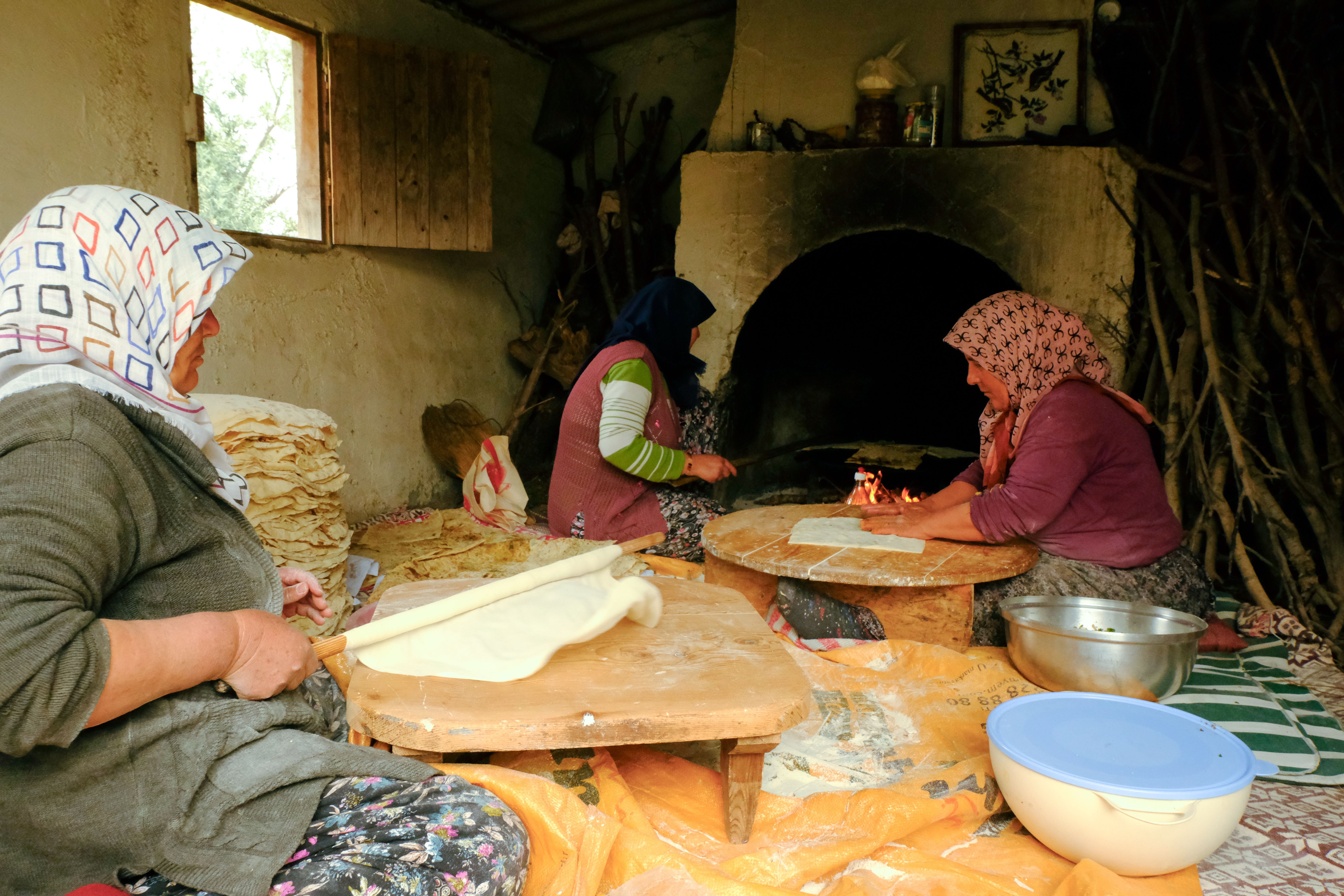 Traditional Women Baking Flatbread in Rustic Setting · Free Stock Photo