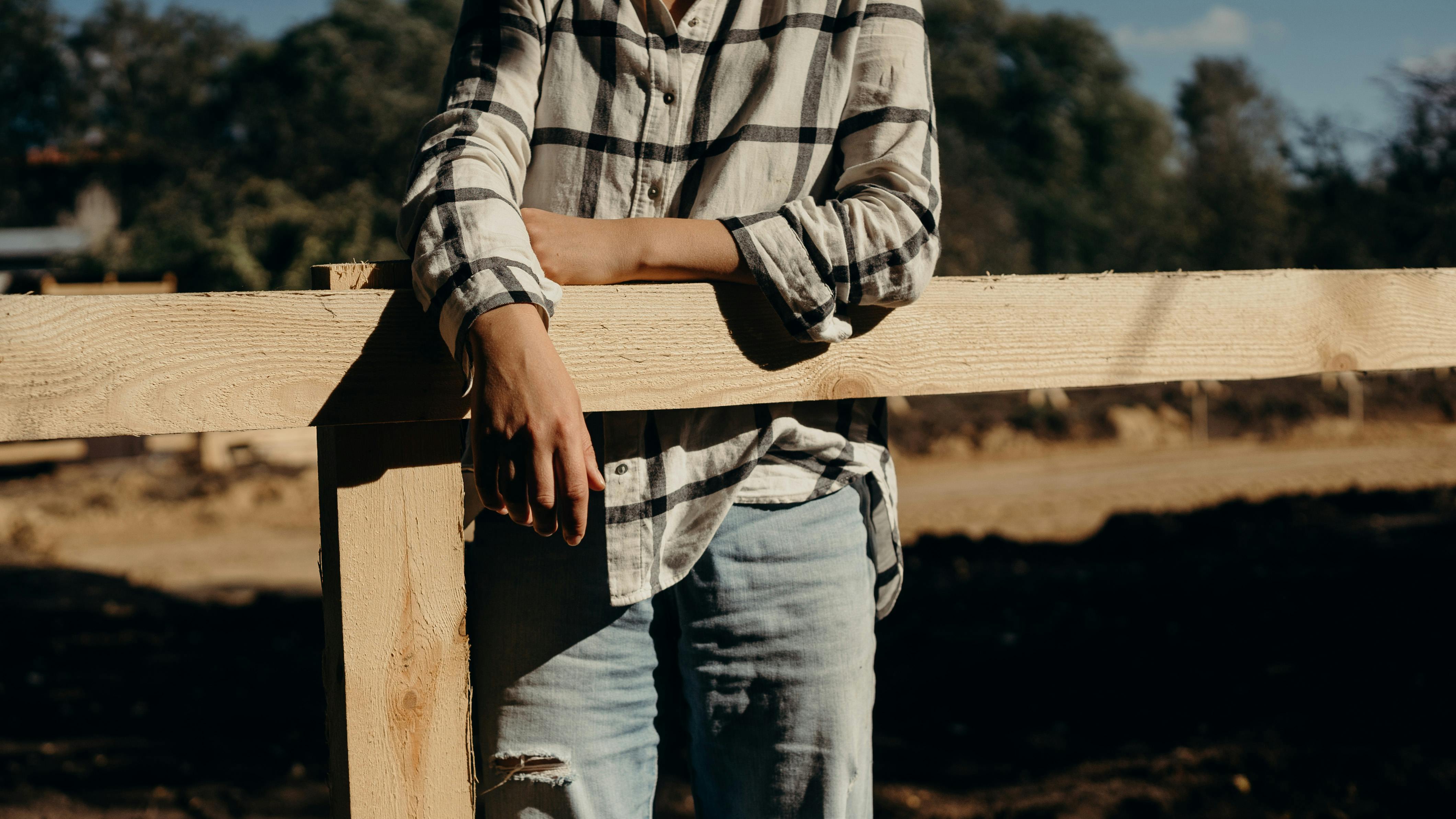 Person Leaning On Fence · Free Stock Photo