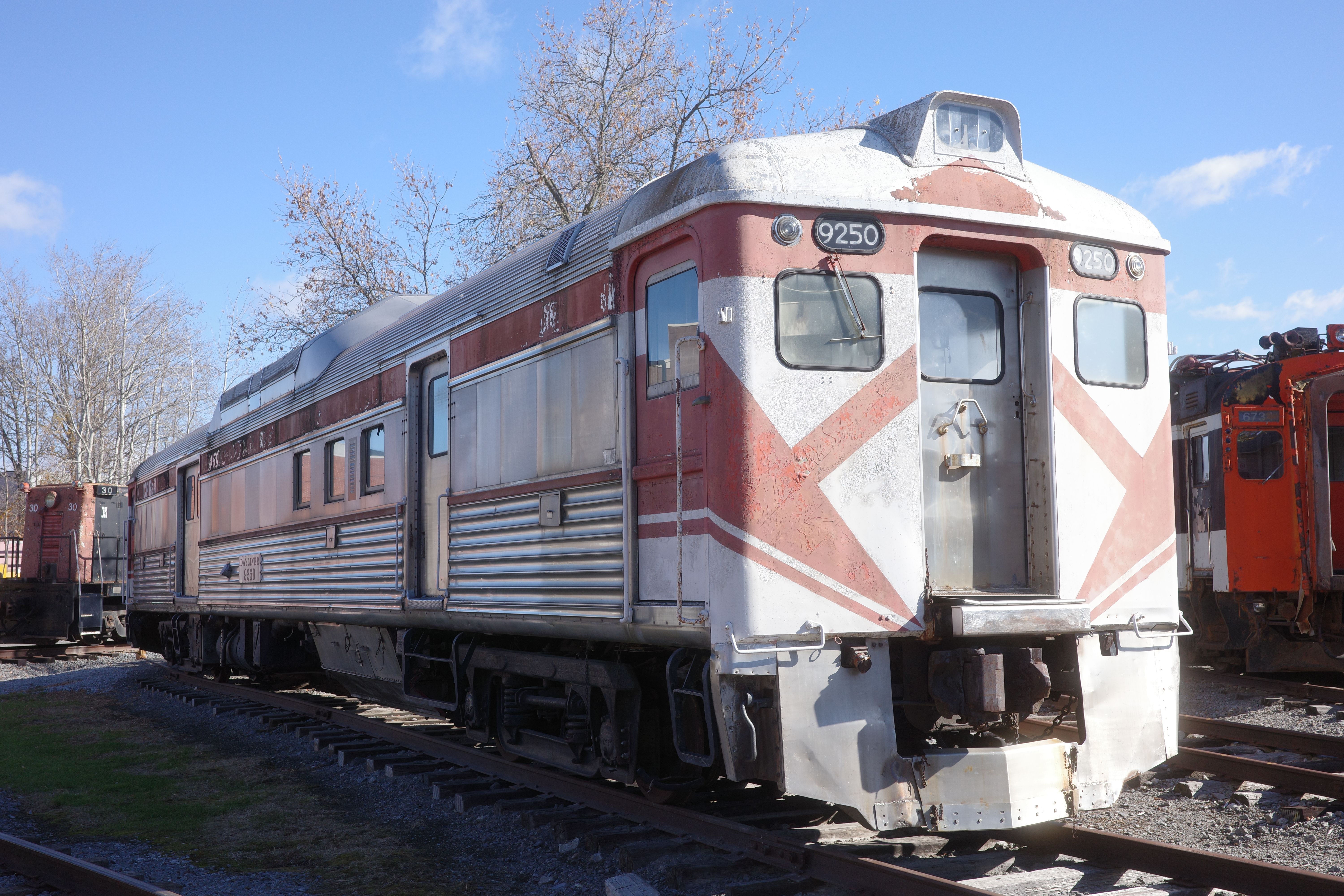 Vintage Train Car with Faded Elegance on Tracks · Free Stock Photo