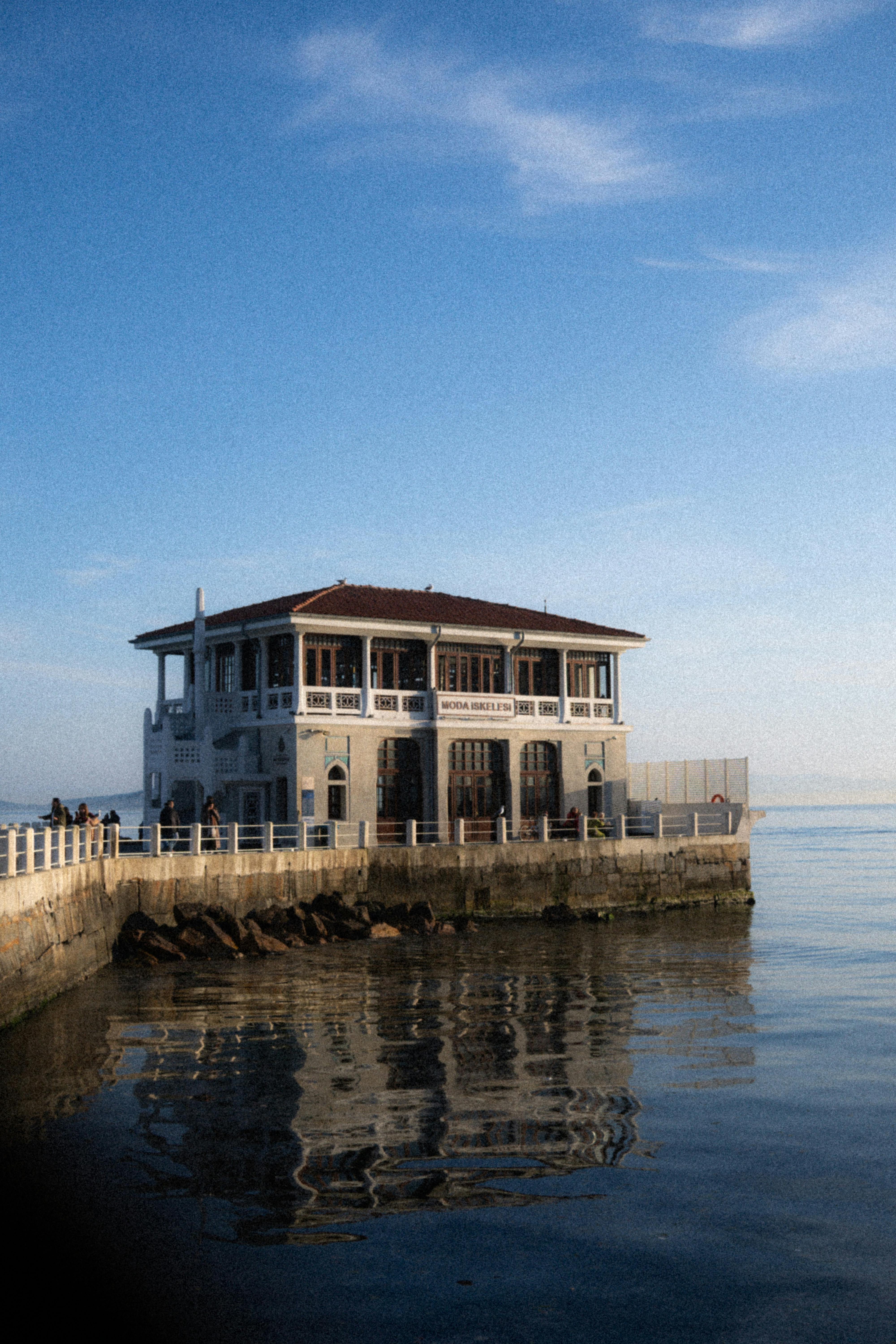 Scenic Building by the Shoreline at Sunrise · Free Stock Photo