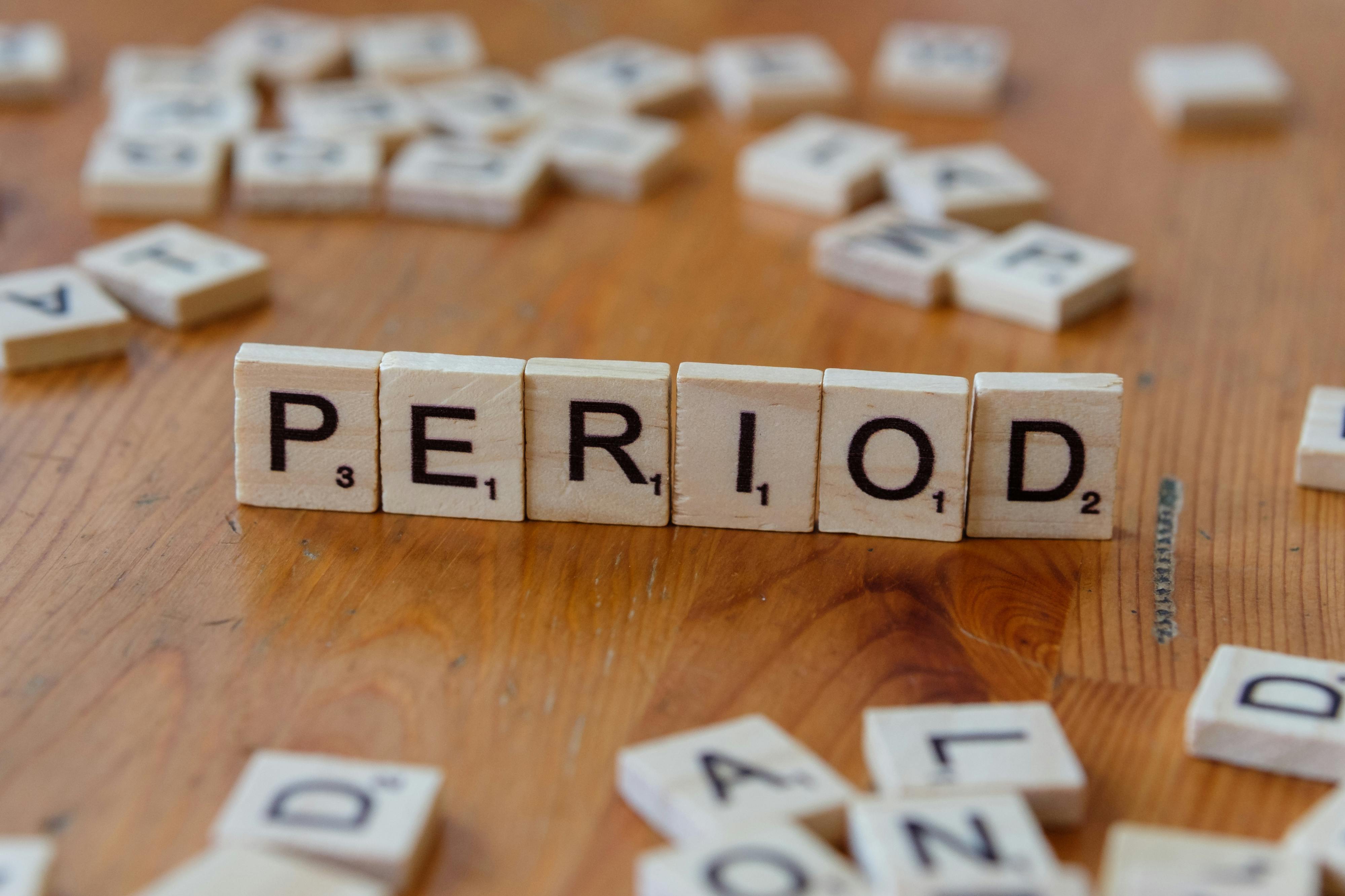 Scrabble Tiles Forming the Word 'Period' on a Wooden Table · Free Stock ...