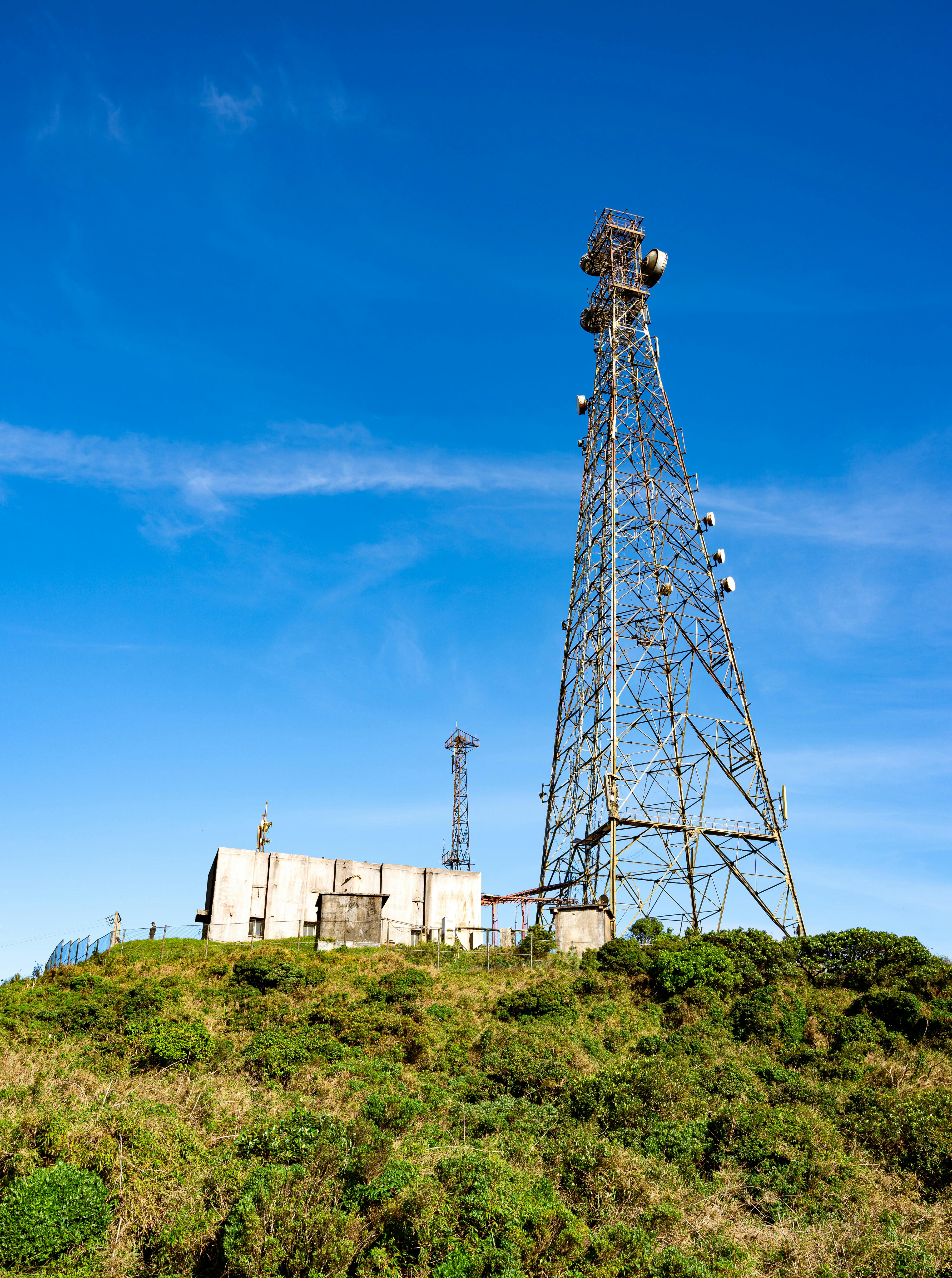 Telecommunication Tower on Hilltop Under Clear Blue Sky · Free Stock Photo