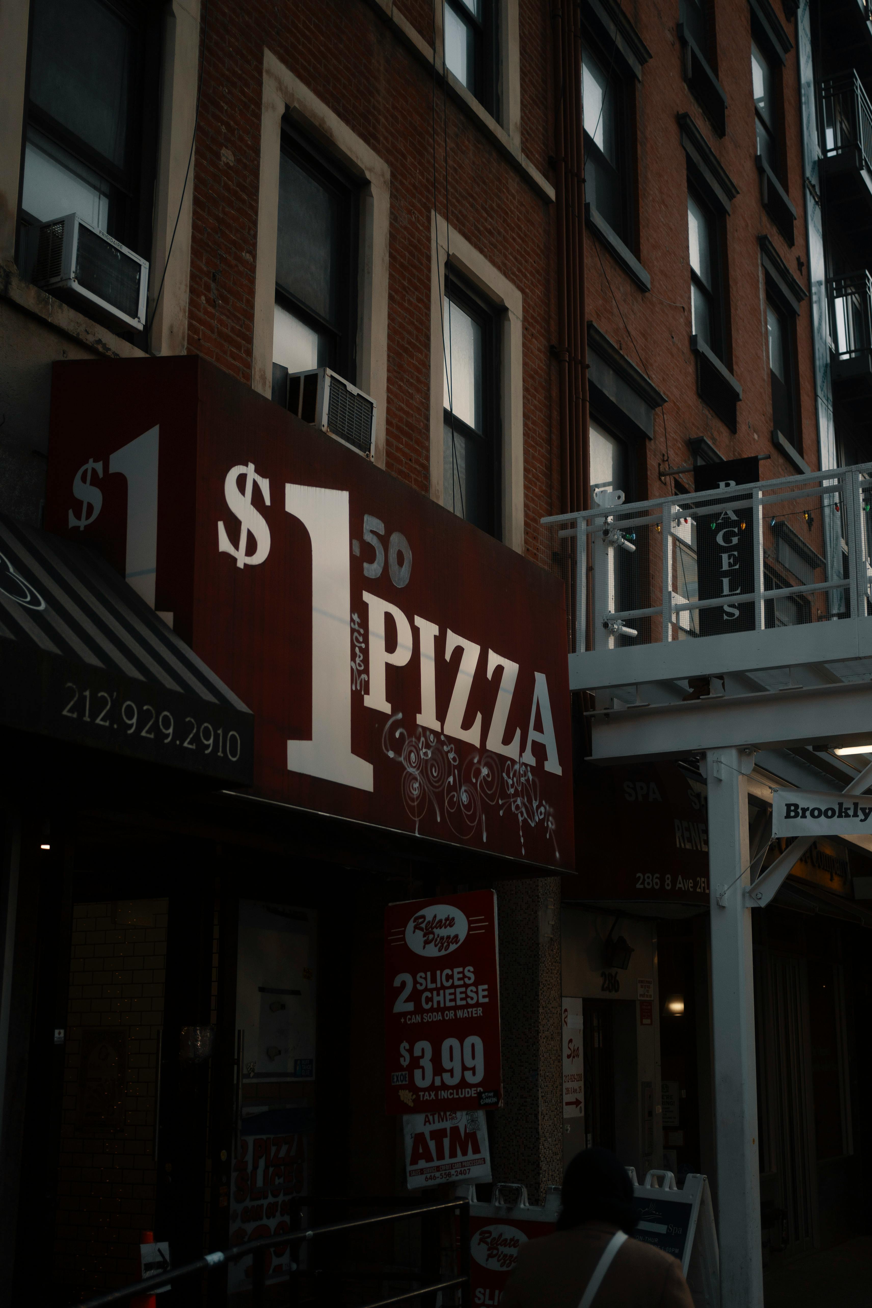 Downtown $1 Pizza Shop Sign on City Street · Free Stock Photo