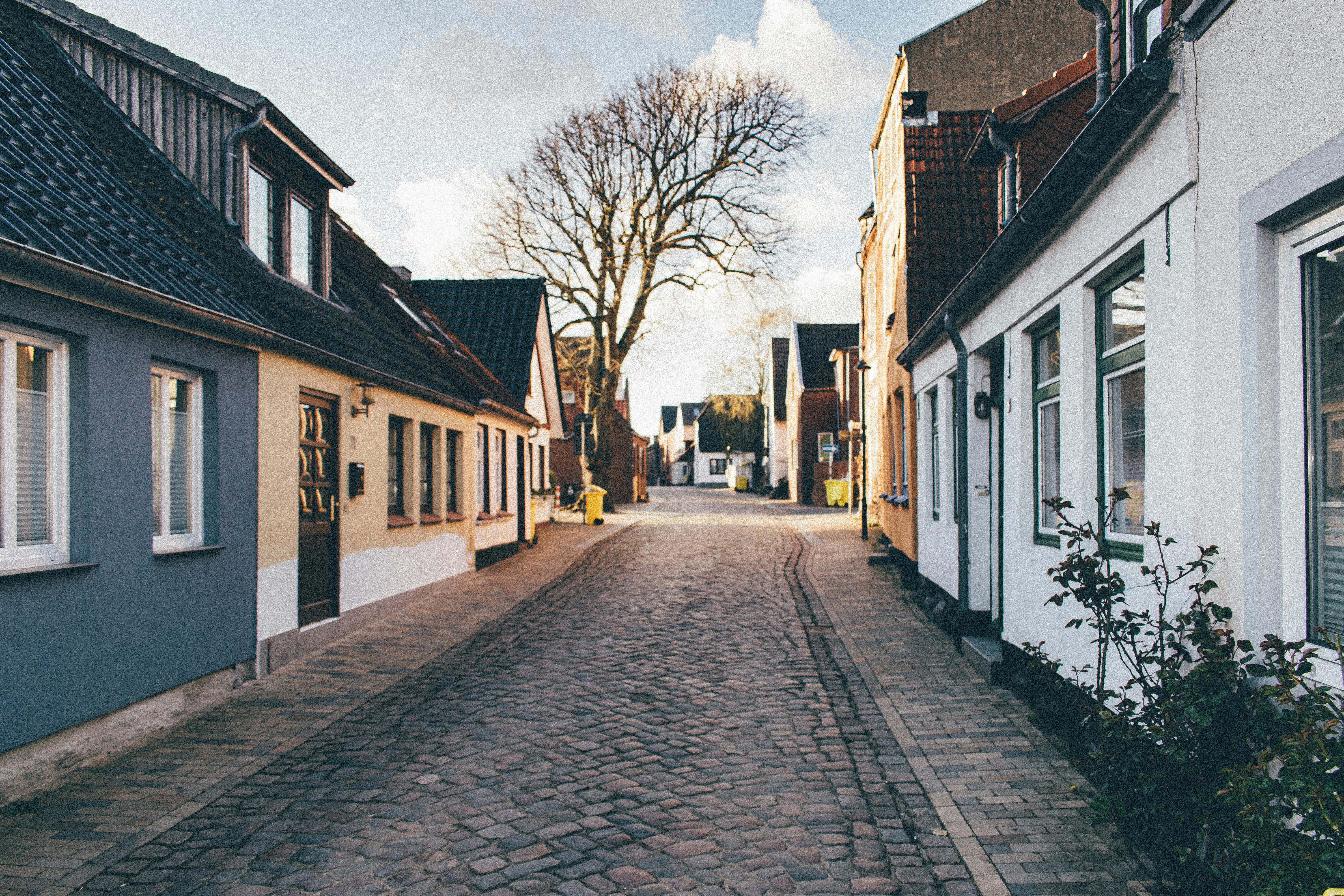 Photo of Street Between Houses · Free Stock Photo