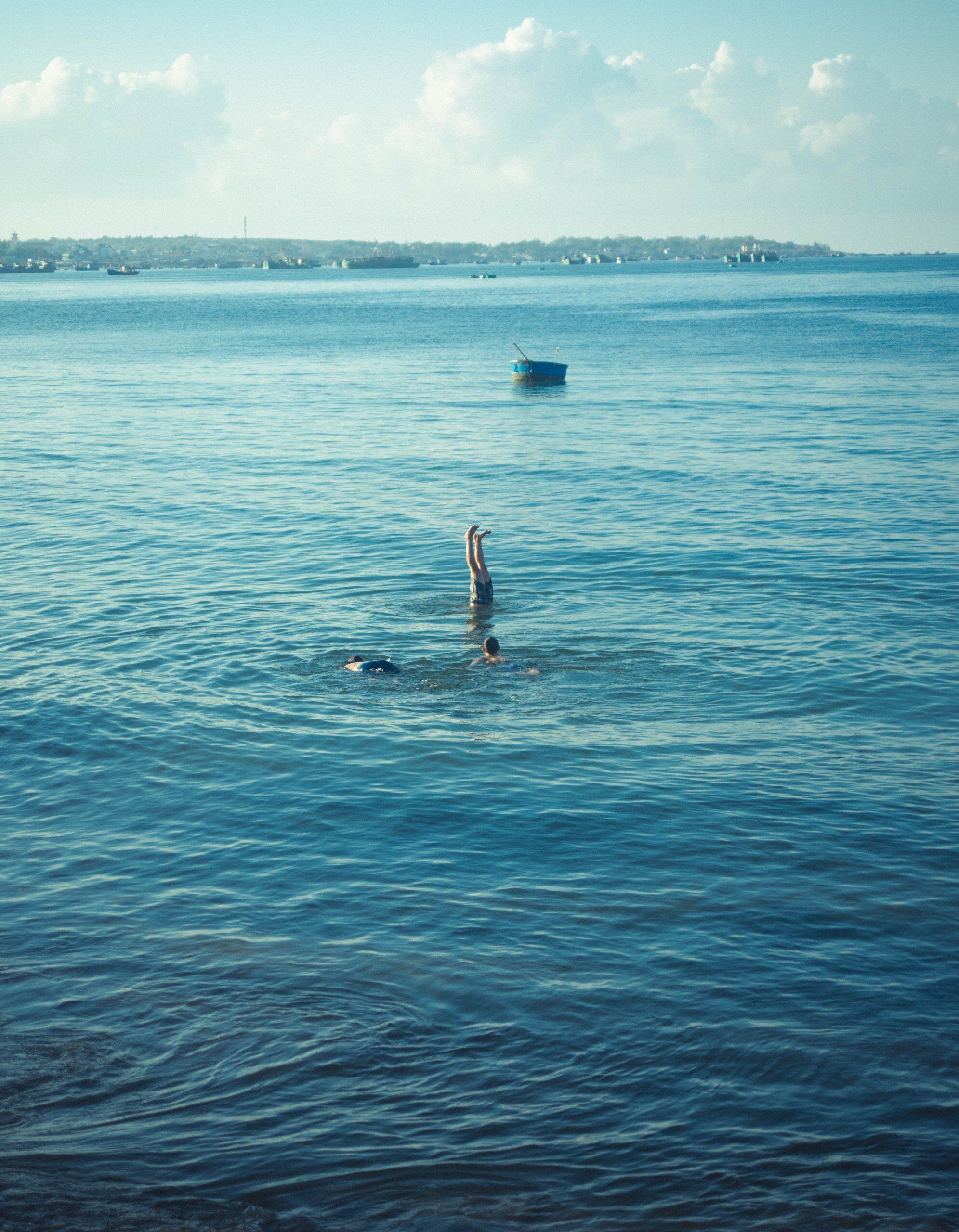 People Enjoying a Refreshing Swim in Serene Waters · Free Stock Photo