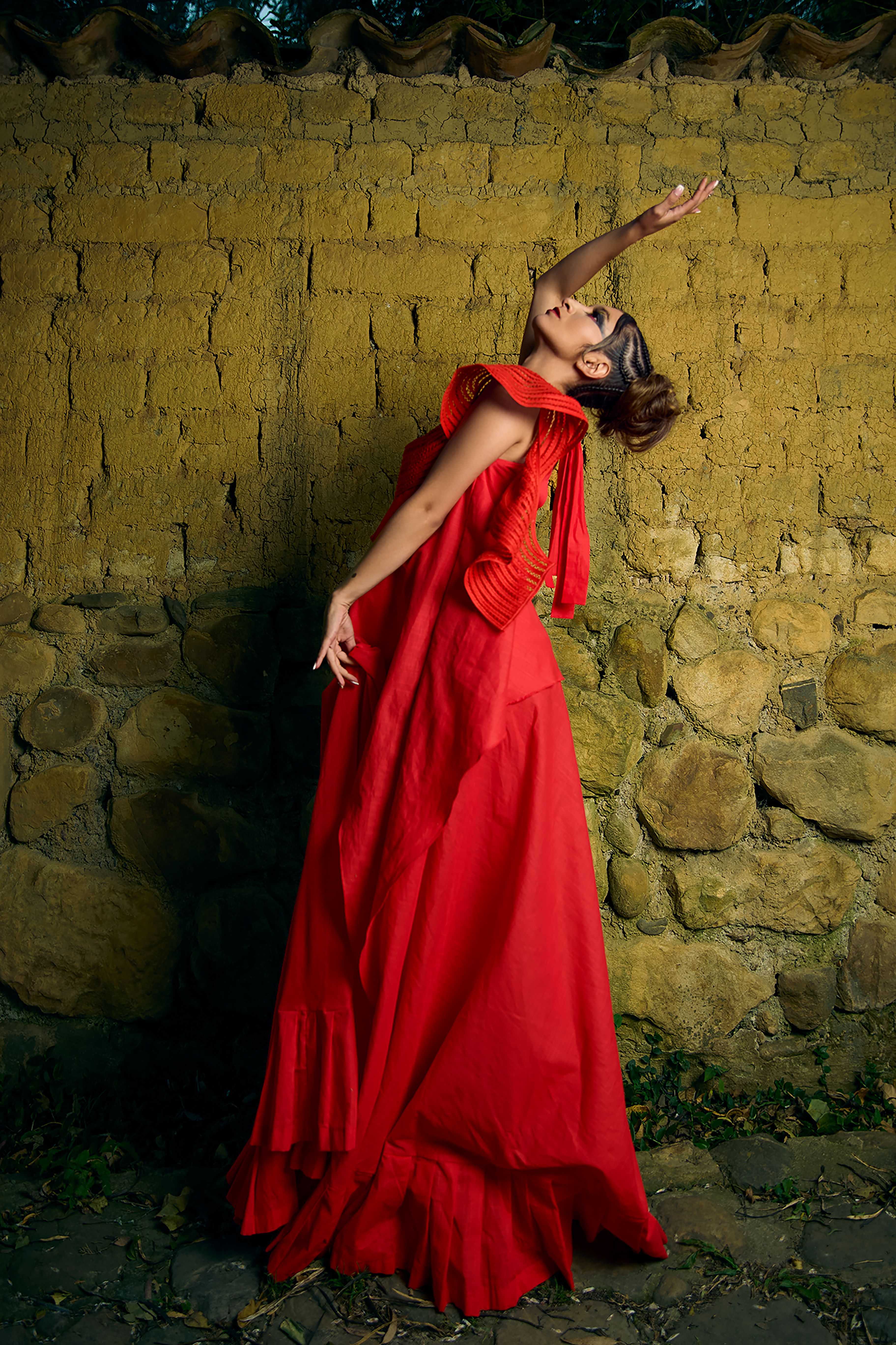 Elegant Woman in Red Dress Against Rustic Wall · Free Stock Photo