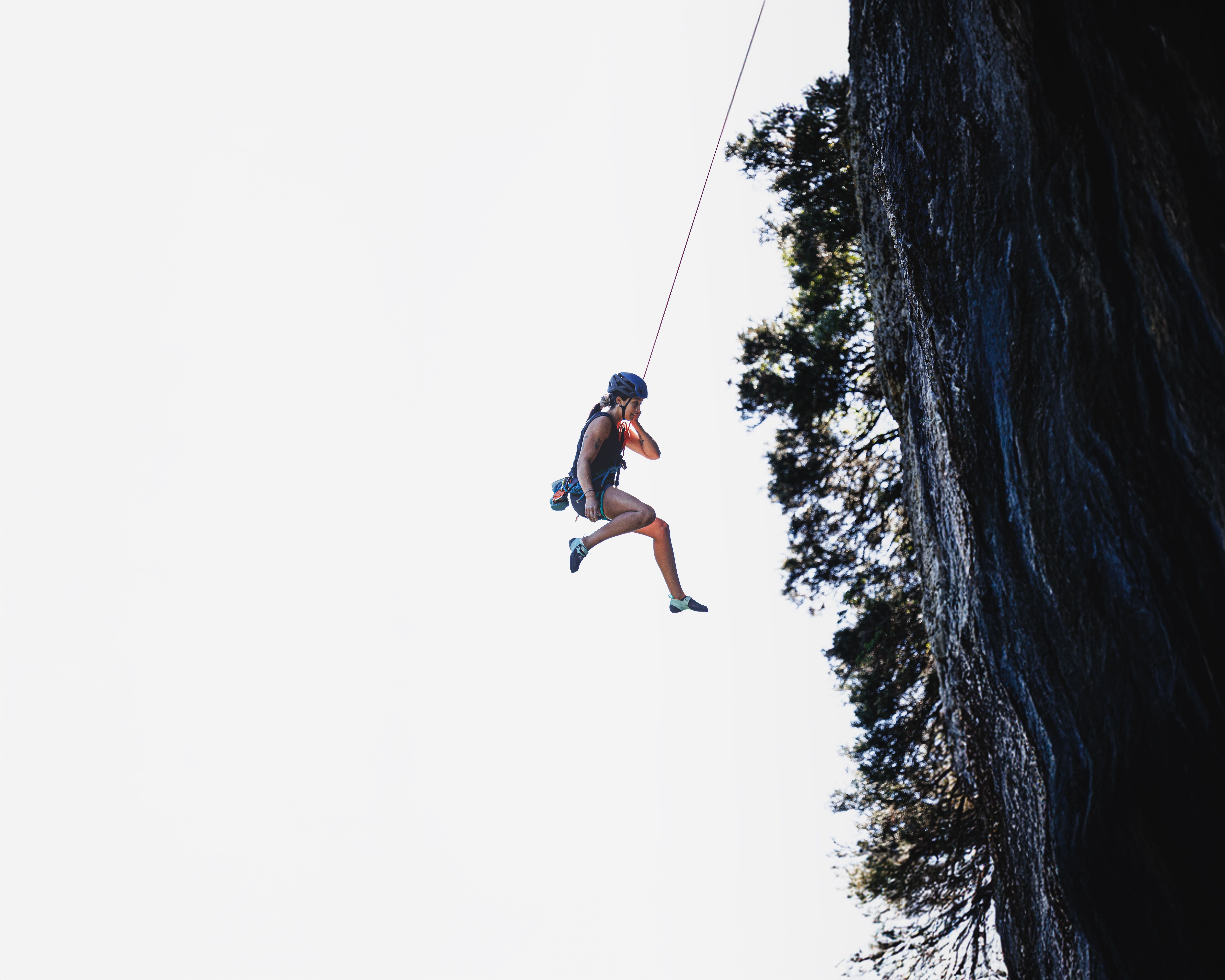 Woman Rappelling Down Cliffside · Free Stock Photo