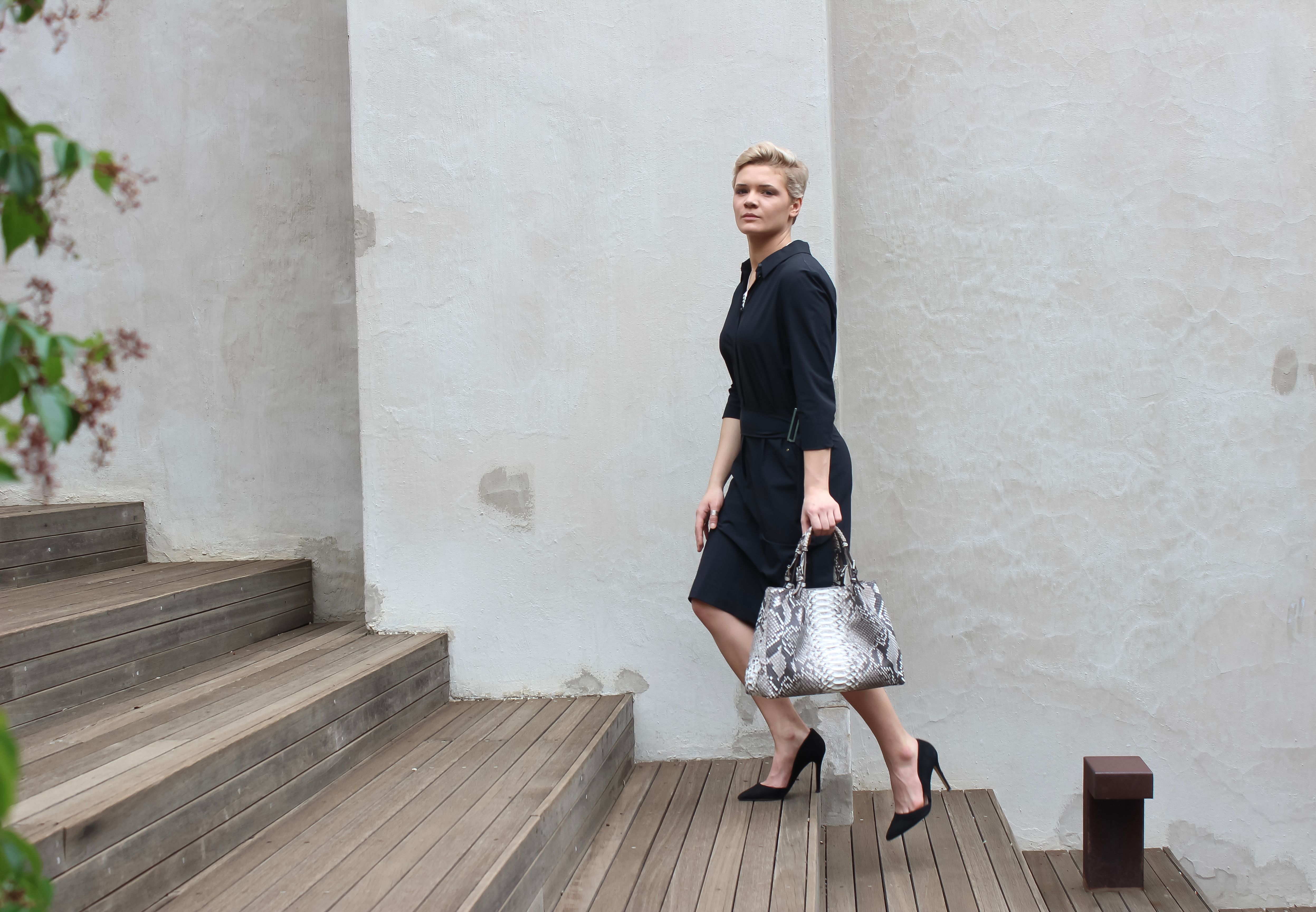 Woman Holding Black Leather Handbag Walking on The Street · Free Stock ...