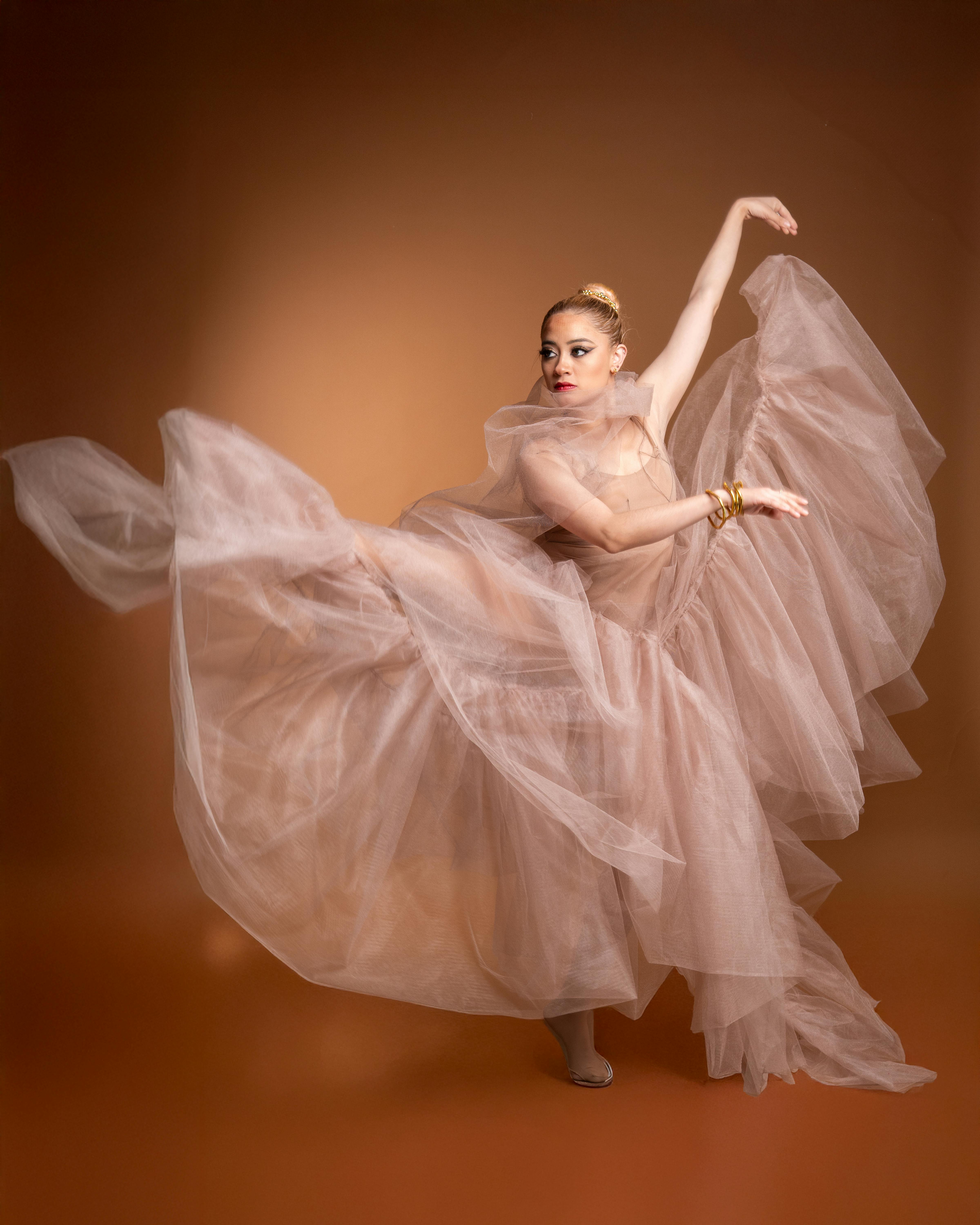 Elegant Ballet Dancer in Flowing Mocha Dress · Free Stock Photo