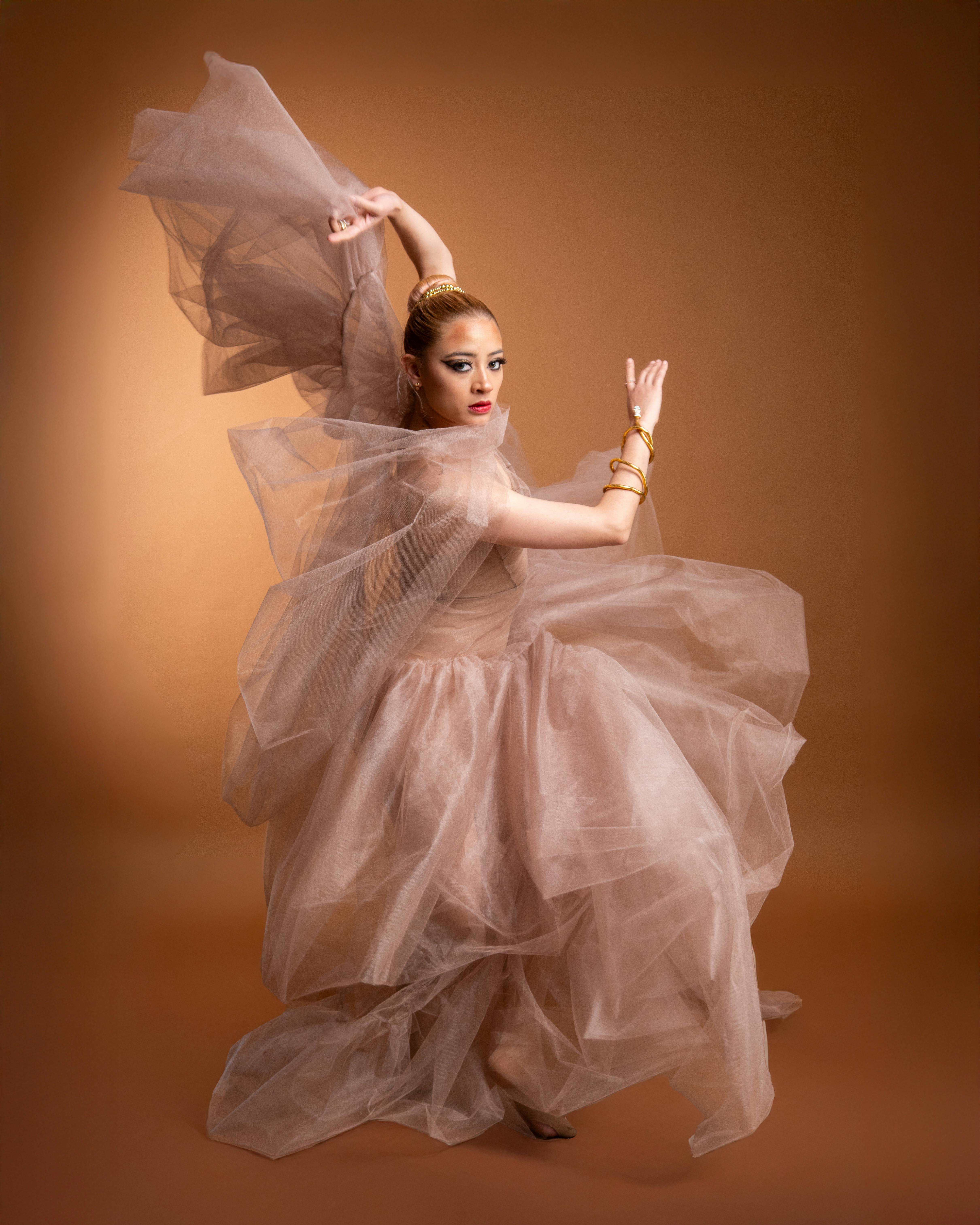 Elegant Ballet Dancer in Mocha Dress · Free Stock Photo
