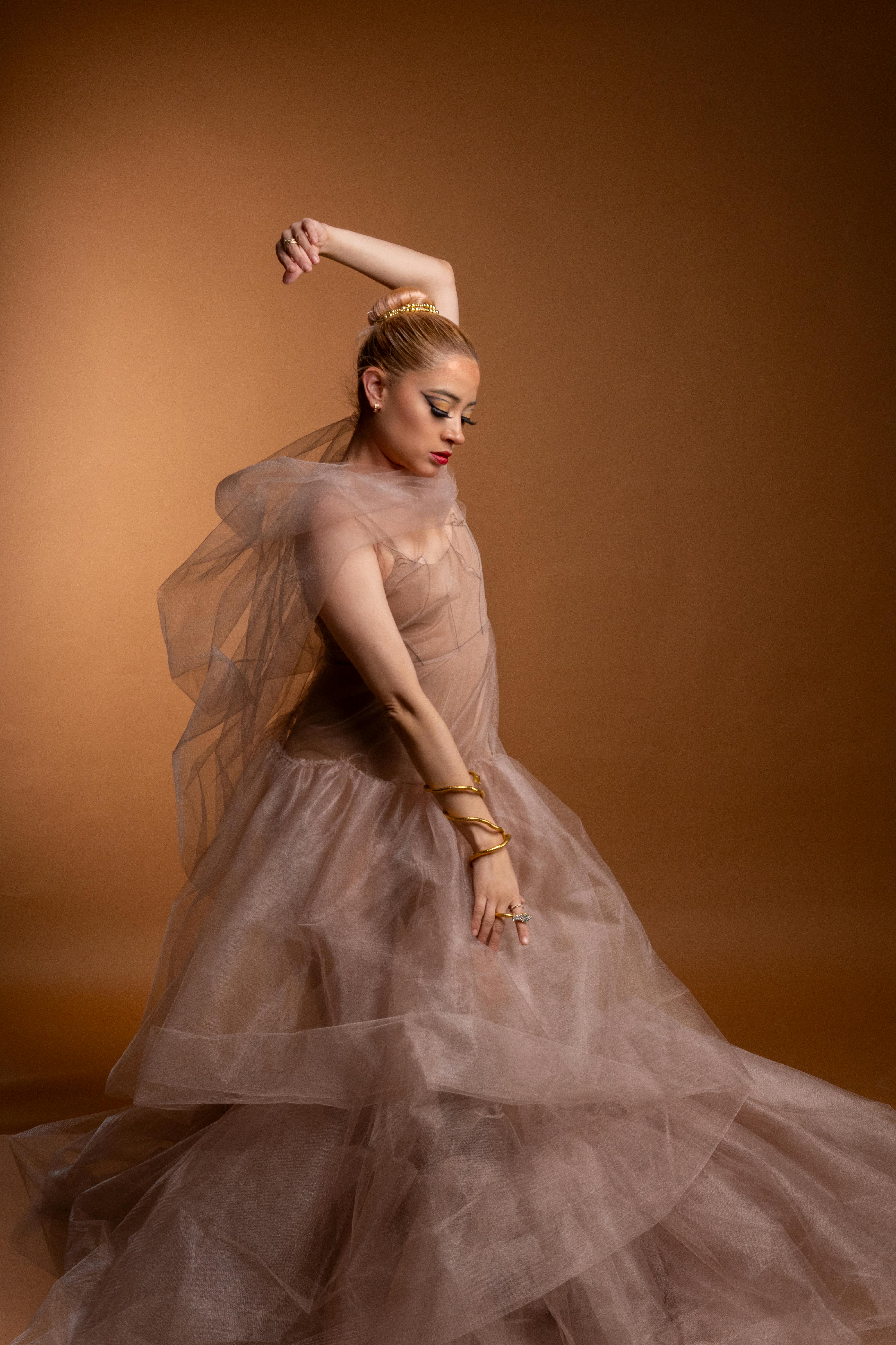Elegant Ballet Dancer in Flowing Mocha Dress · Free Stock Photo