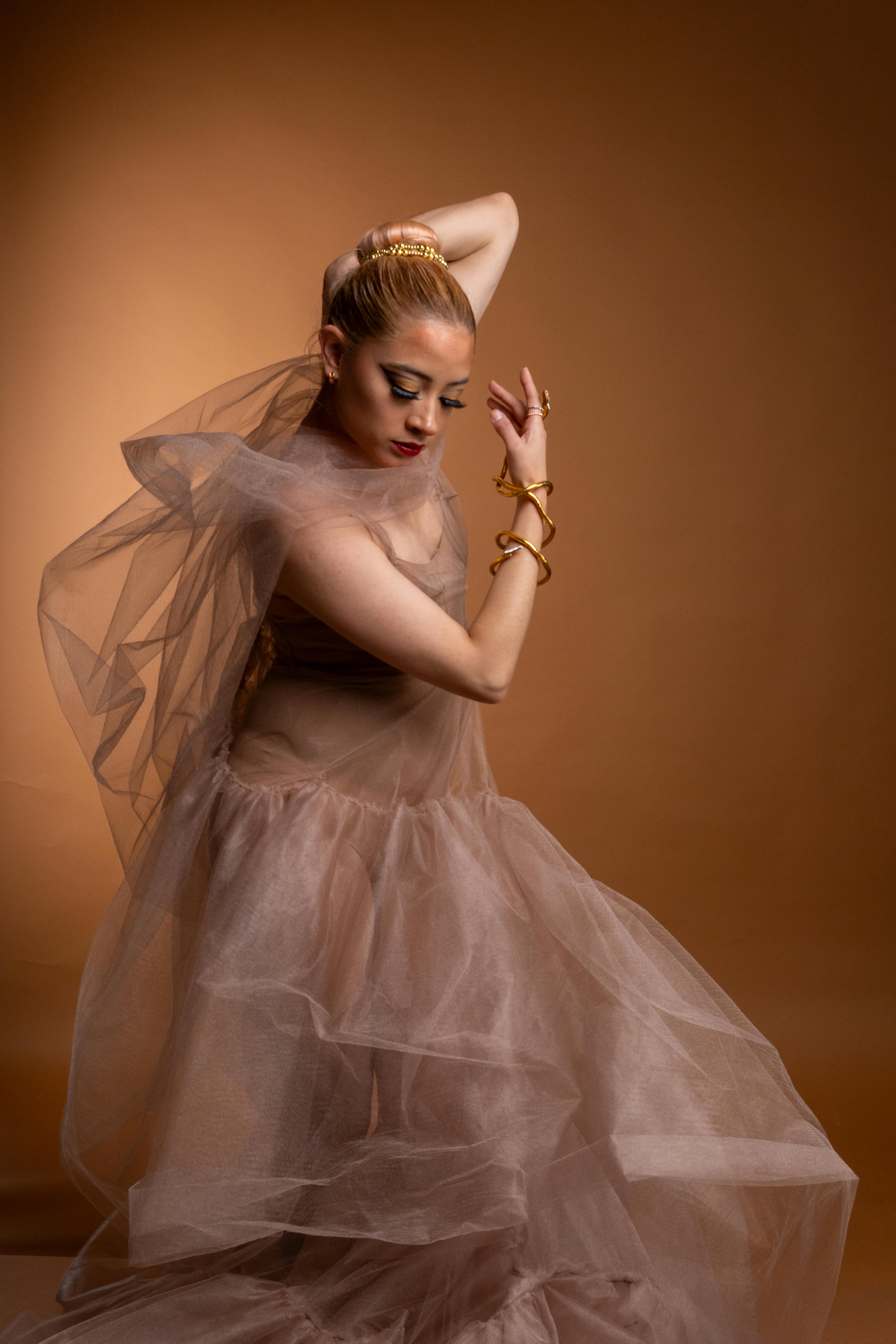 Elegant Ballet Dancer in Mocha Dress Posing · Free Stock Photo