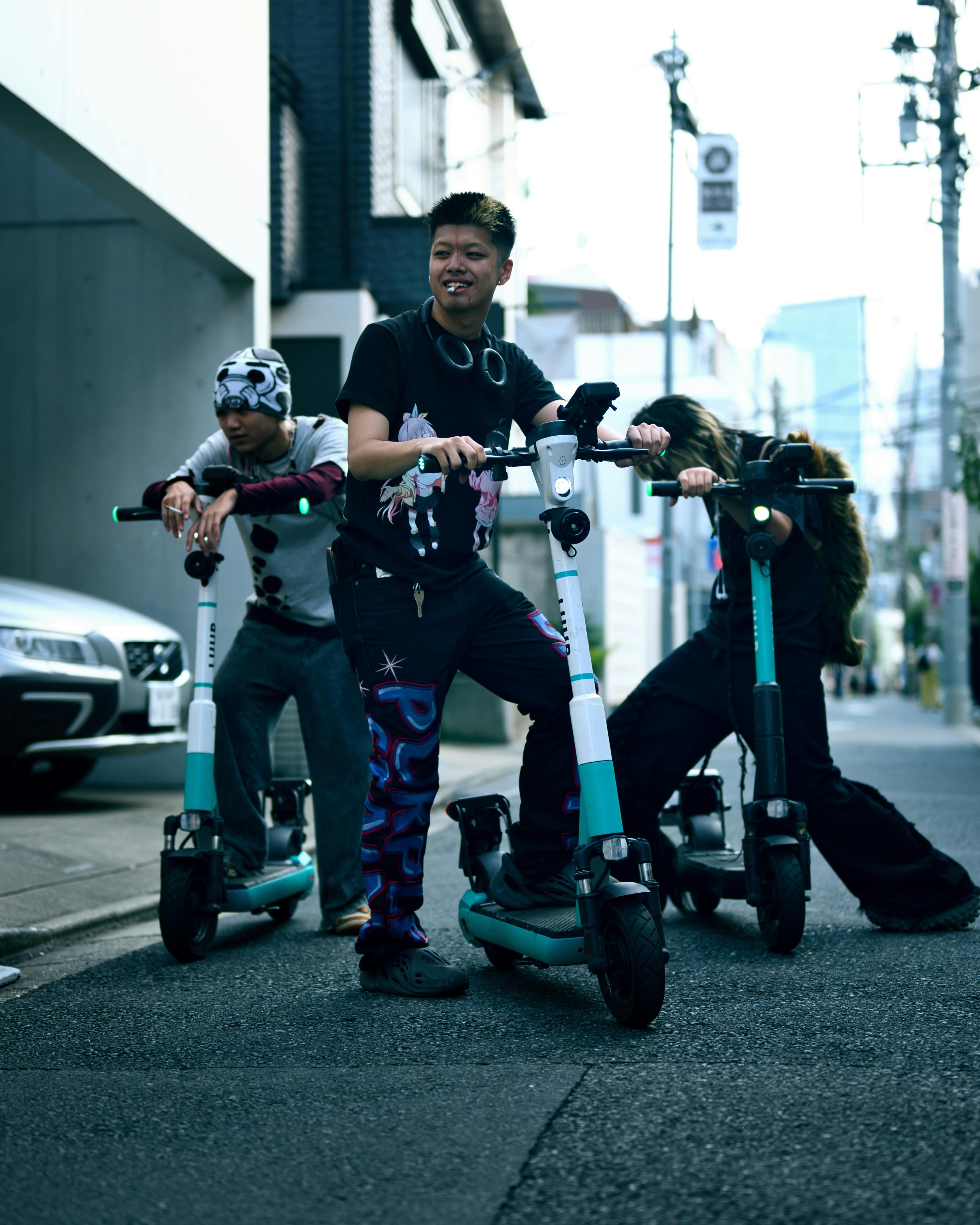 Young Adults Riding Electric Scooters in Tokyo · Free Stock Photo