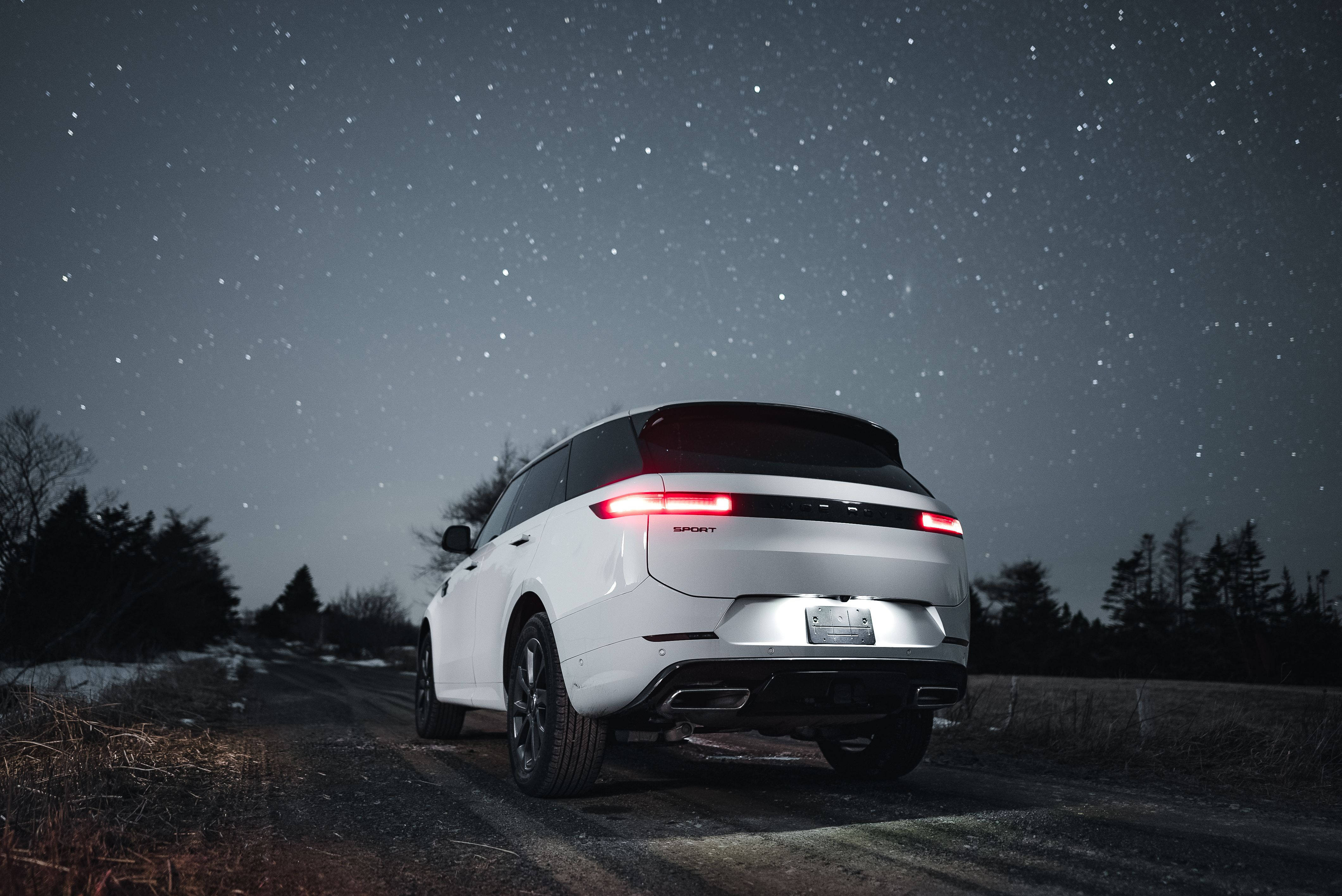 Luxury SUV Under Starry Night Sky on Rural Road · Free Stock Photo