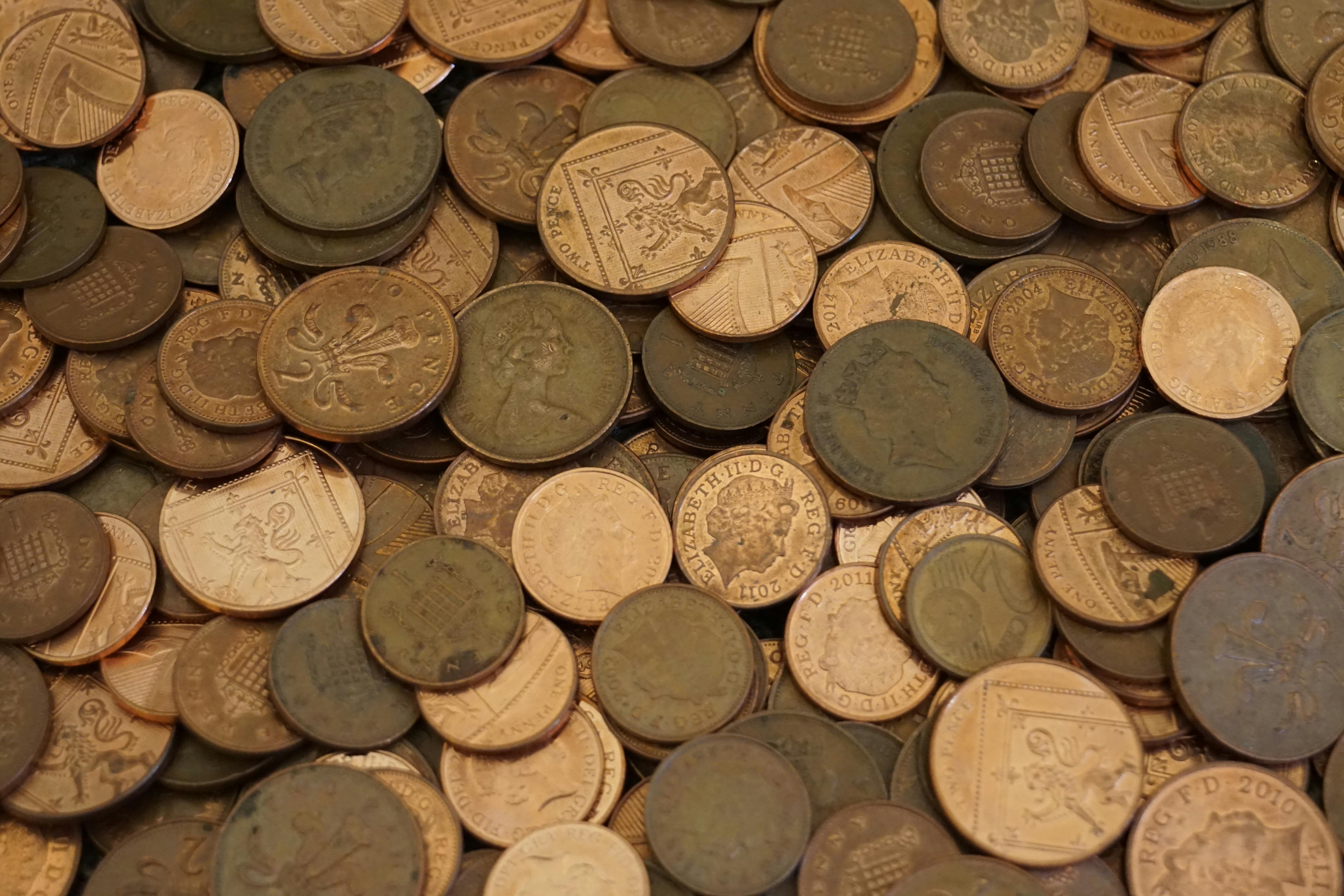 Close-up of Vintage Coins with Varied Designs · Free Stock Photo