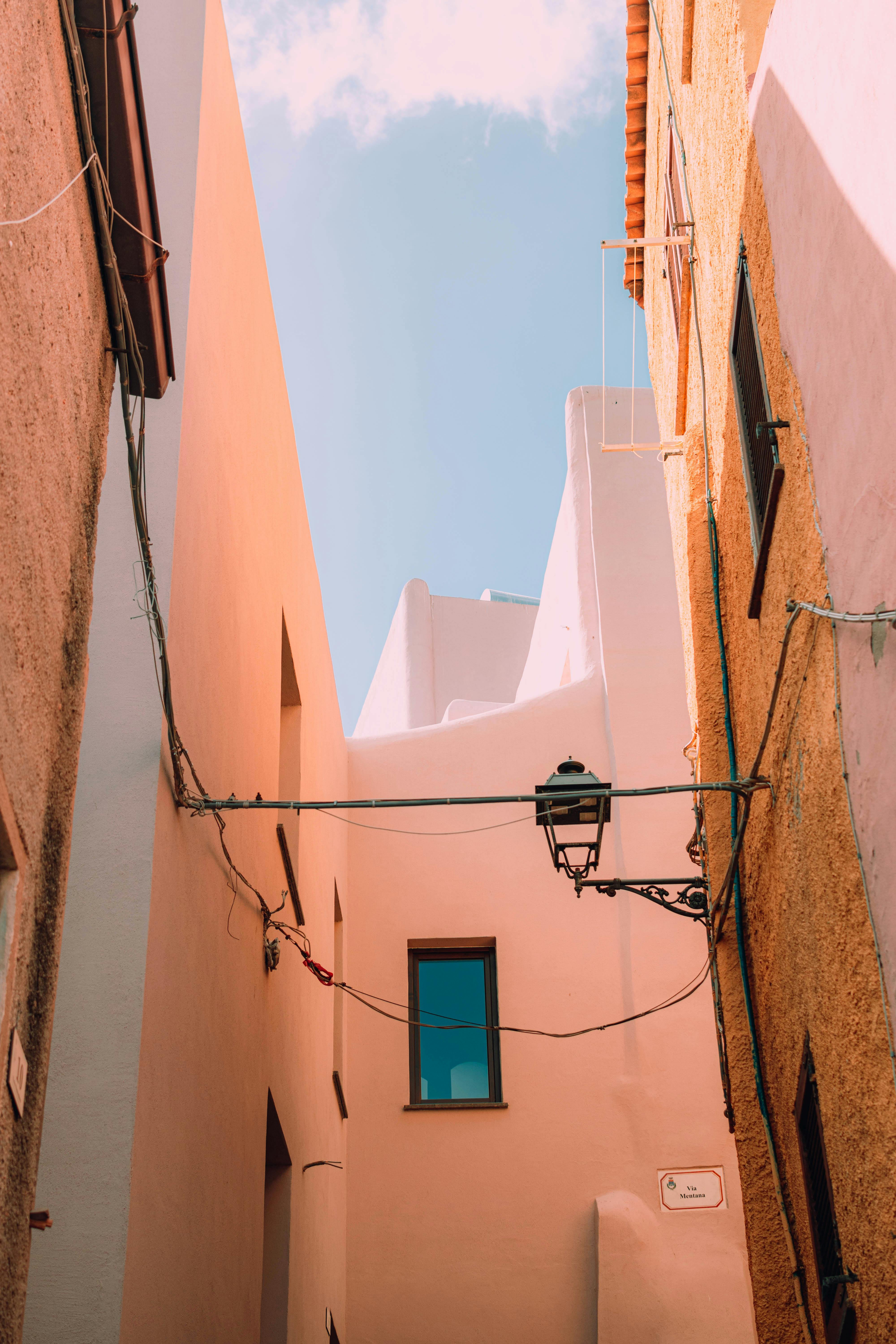 Narrow Mediterranean Alleyway with Bright Stucco Walls · Free Stock Photo