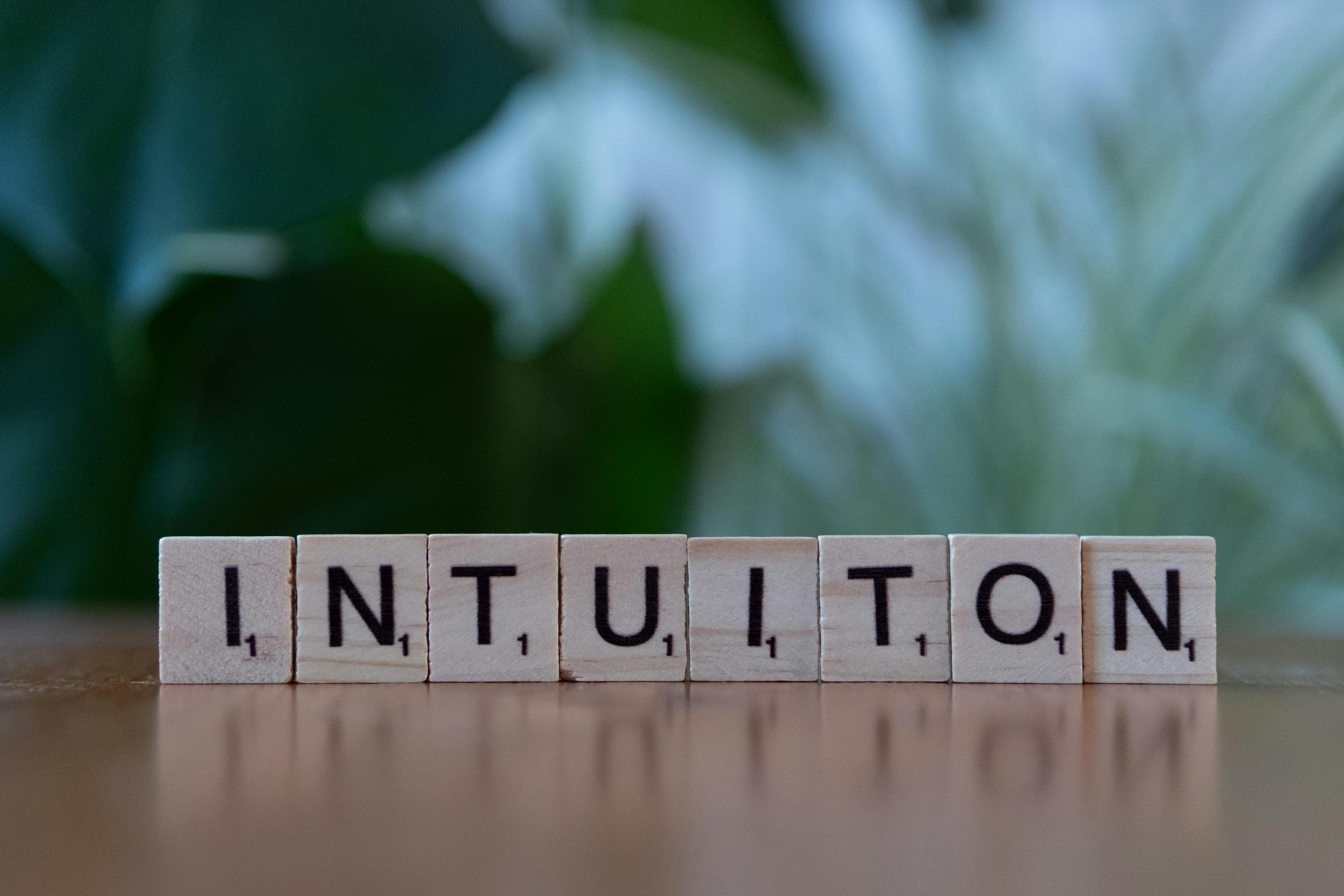 Intuition Word Tiles on a Wooden Surface · Free Stock Photo