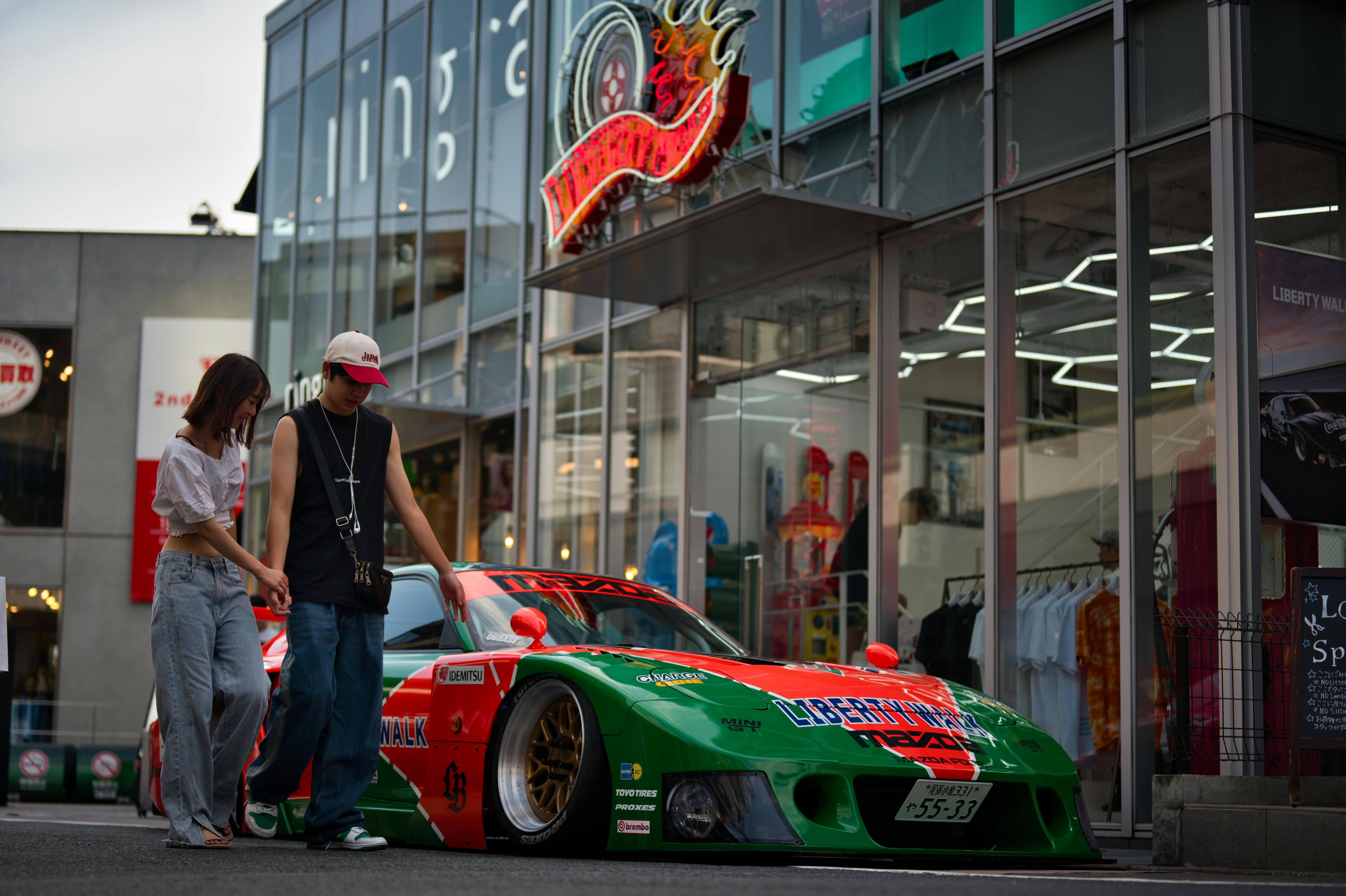 Vibrant Tokyo Street with Tuning Car and Shoppers · Free Stock Photo
