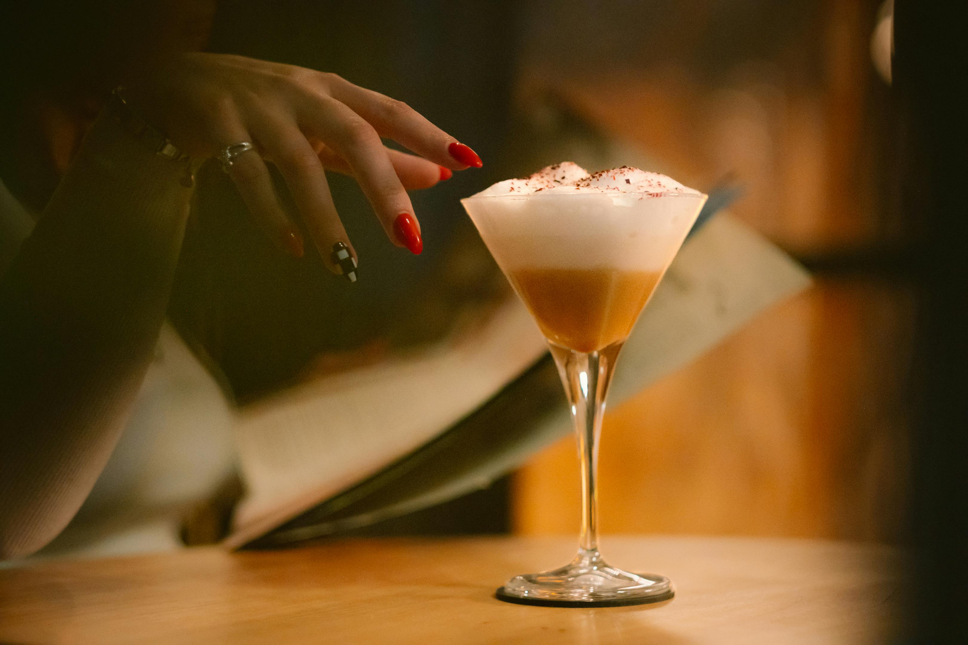 Elegant Cocktail with Foam Top in Dim Bar Setting · Free Stock Photo