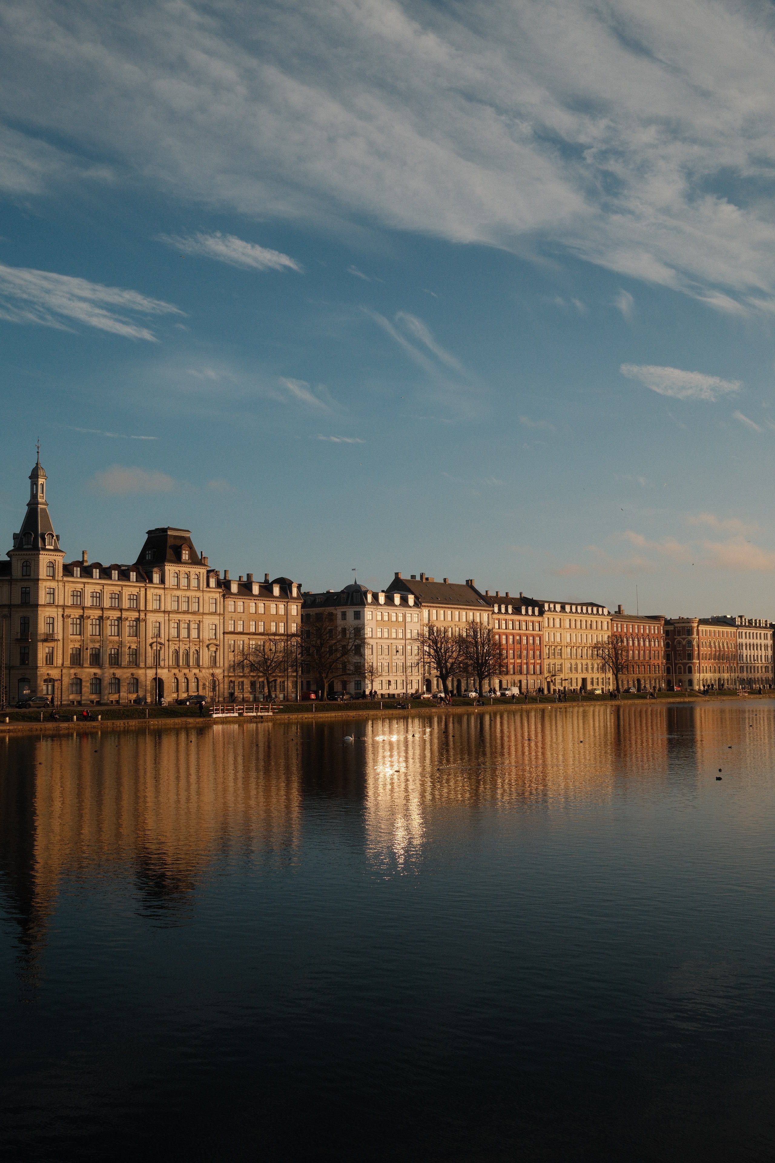 Scenic View of Riverside Buildings at Sunset · Free Stock Photo
