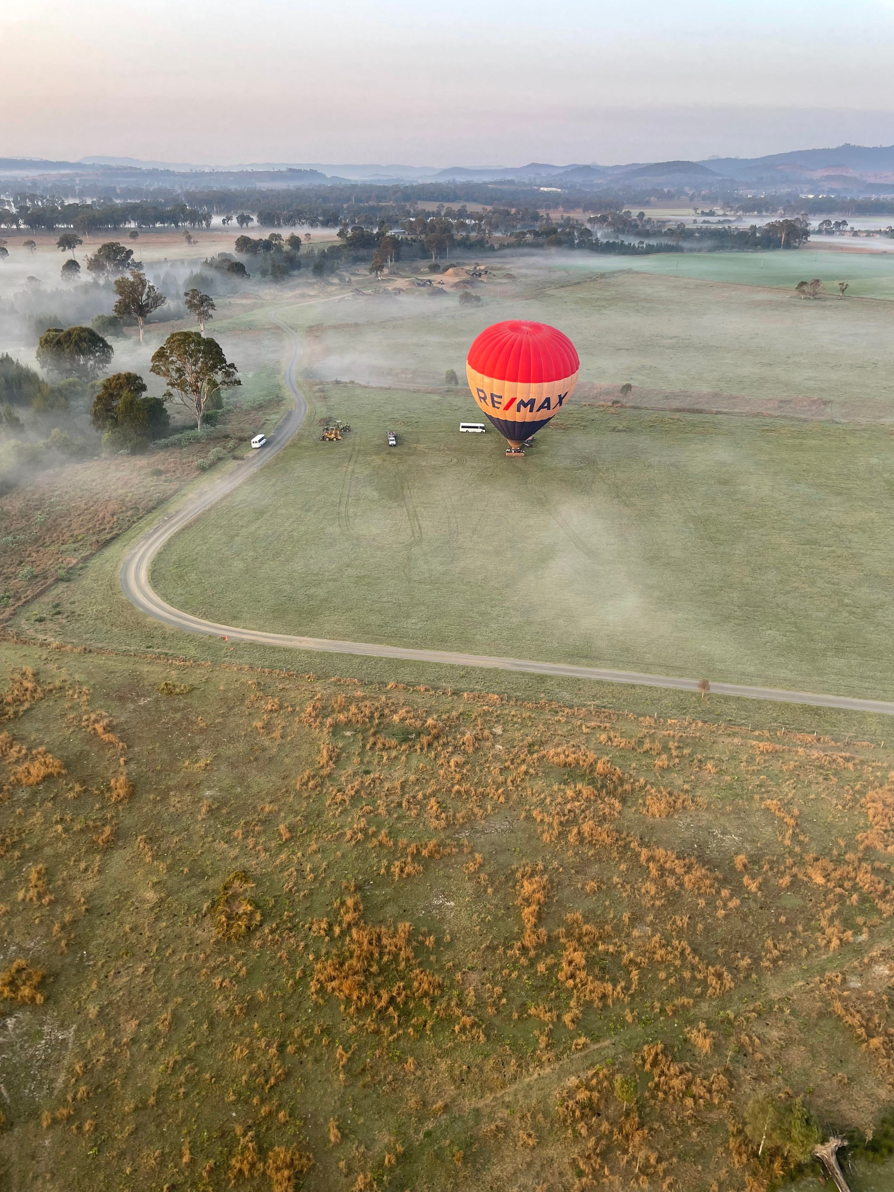 Scenic Hot Air Balloon Over Misty Countryside · Free Stock Photo