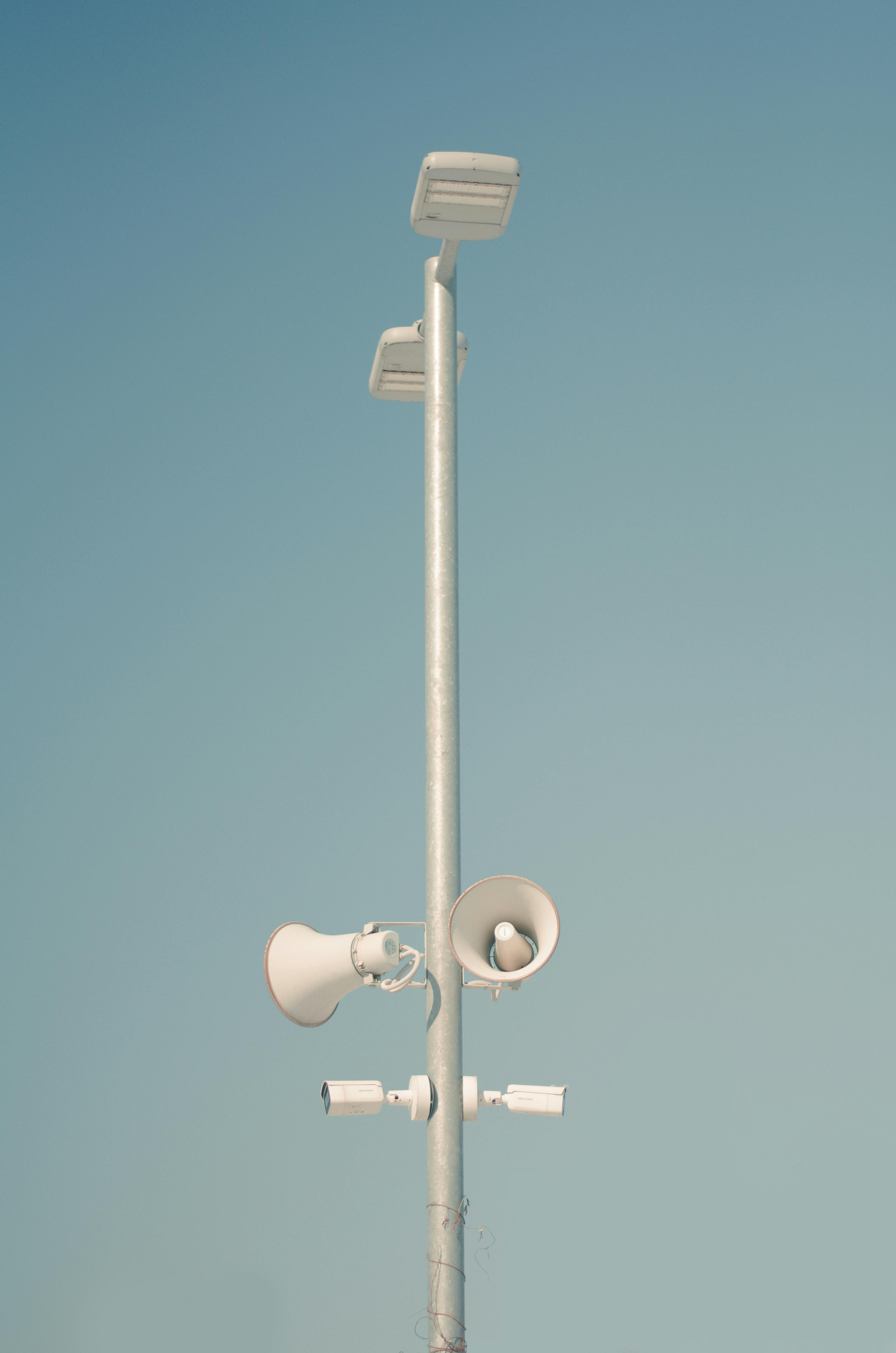 Megaphone Speakers on Wooden Post · Free Stock Photo