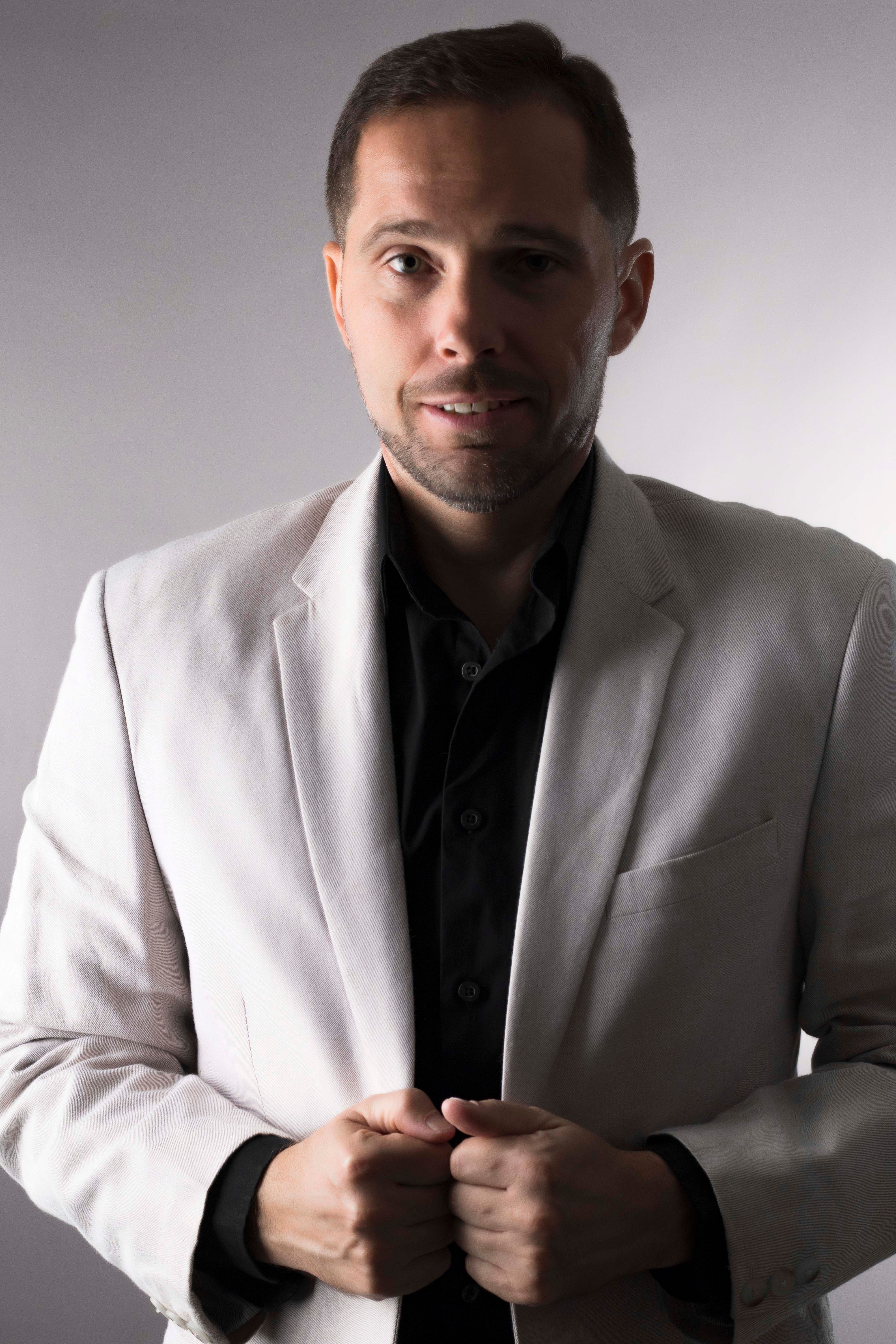 Confident Man in White Suit Portrait · Free Stock Photo
