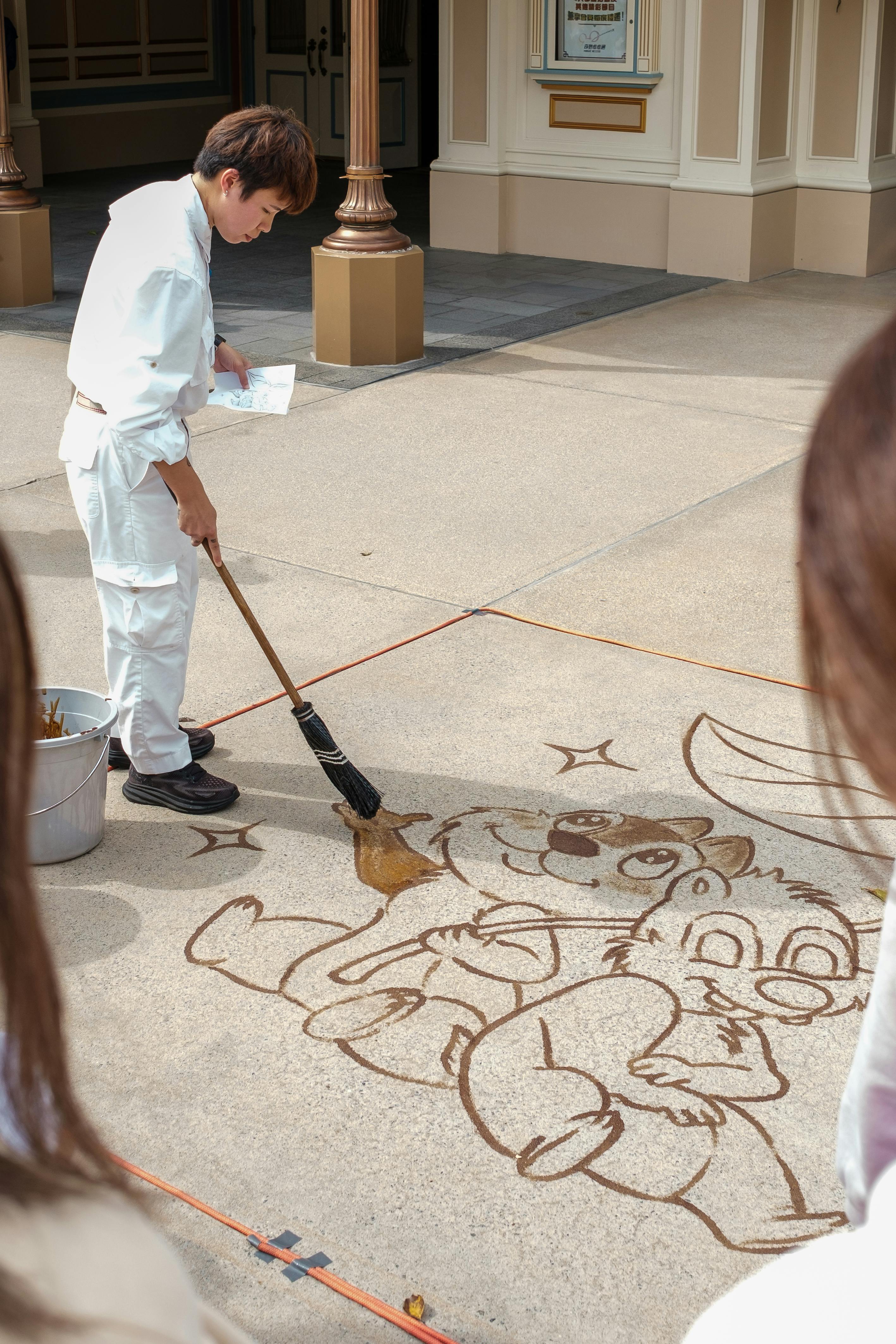 Street Artist Painting Cartoon Characters on Pavement · Free Stock Photo
