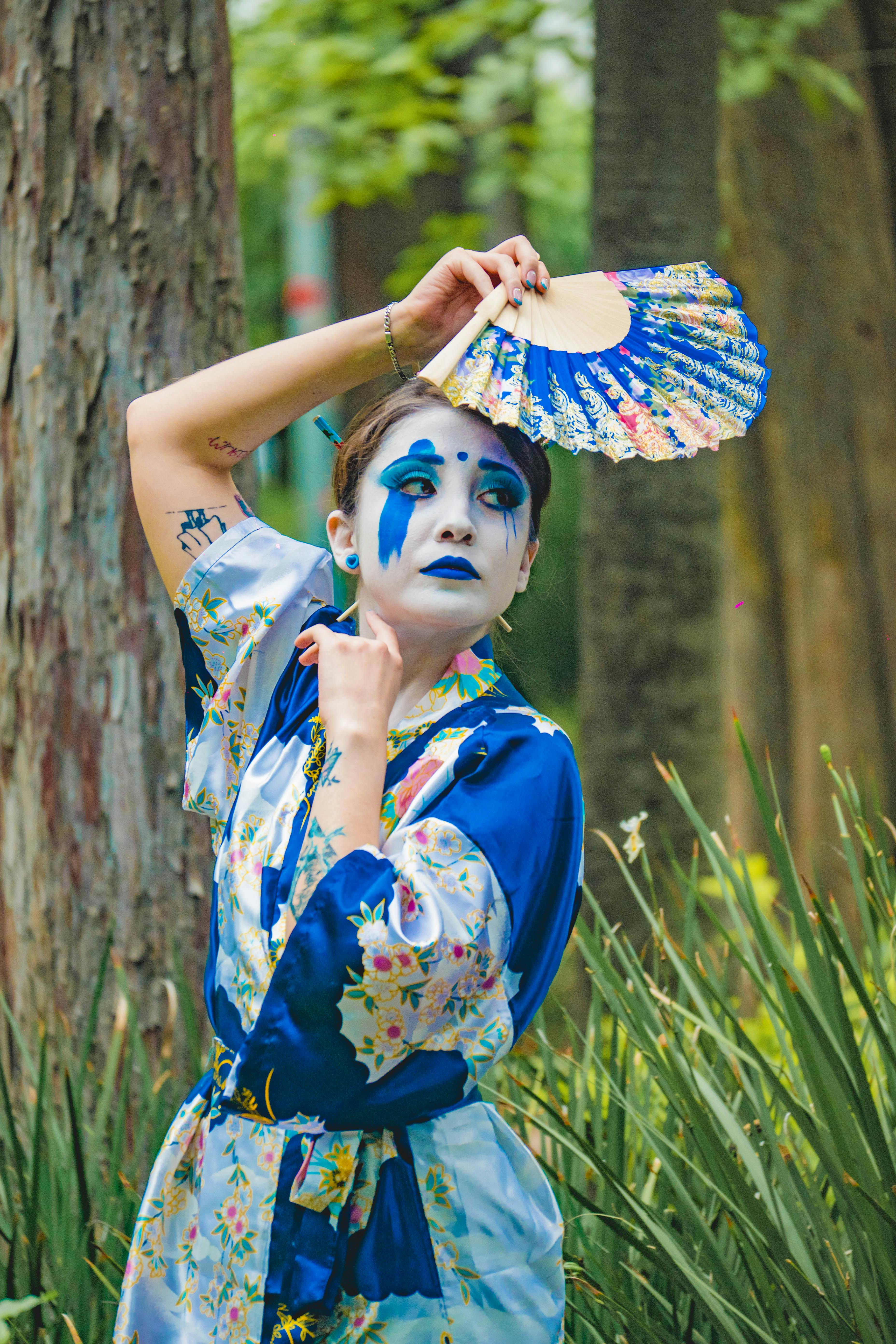 Artistic Portrait with Dramatic Makeup and Fan · Free Stock Photo