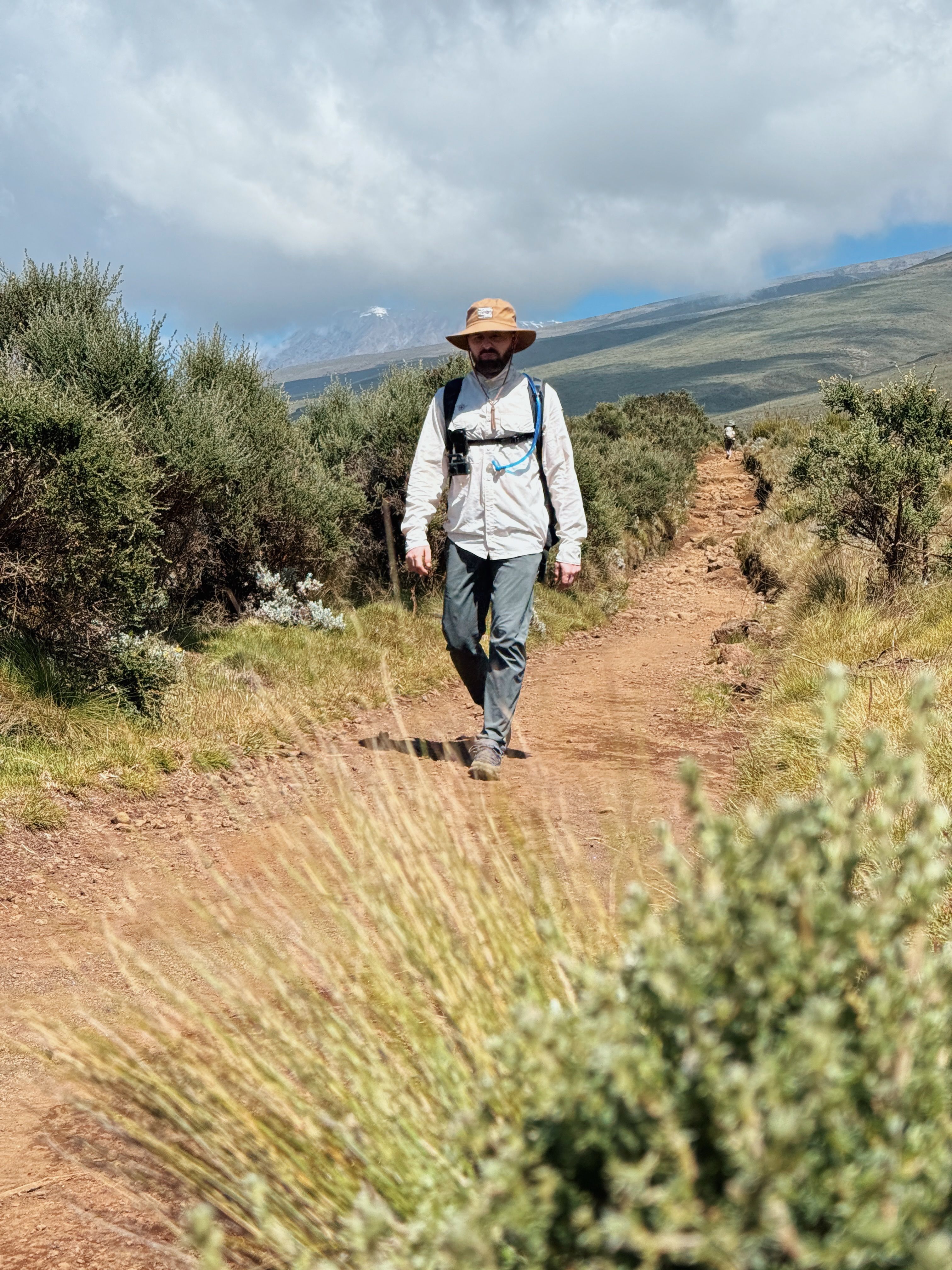 Hiker Exploring Mountain Trail on Sunny Day · Free Stock Photo