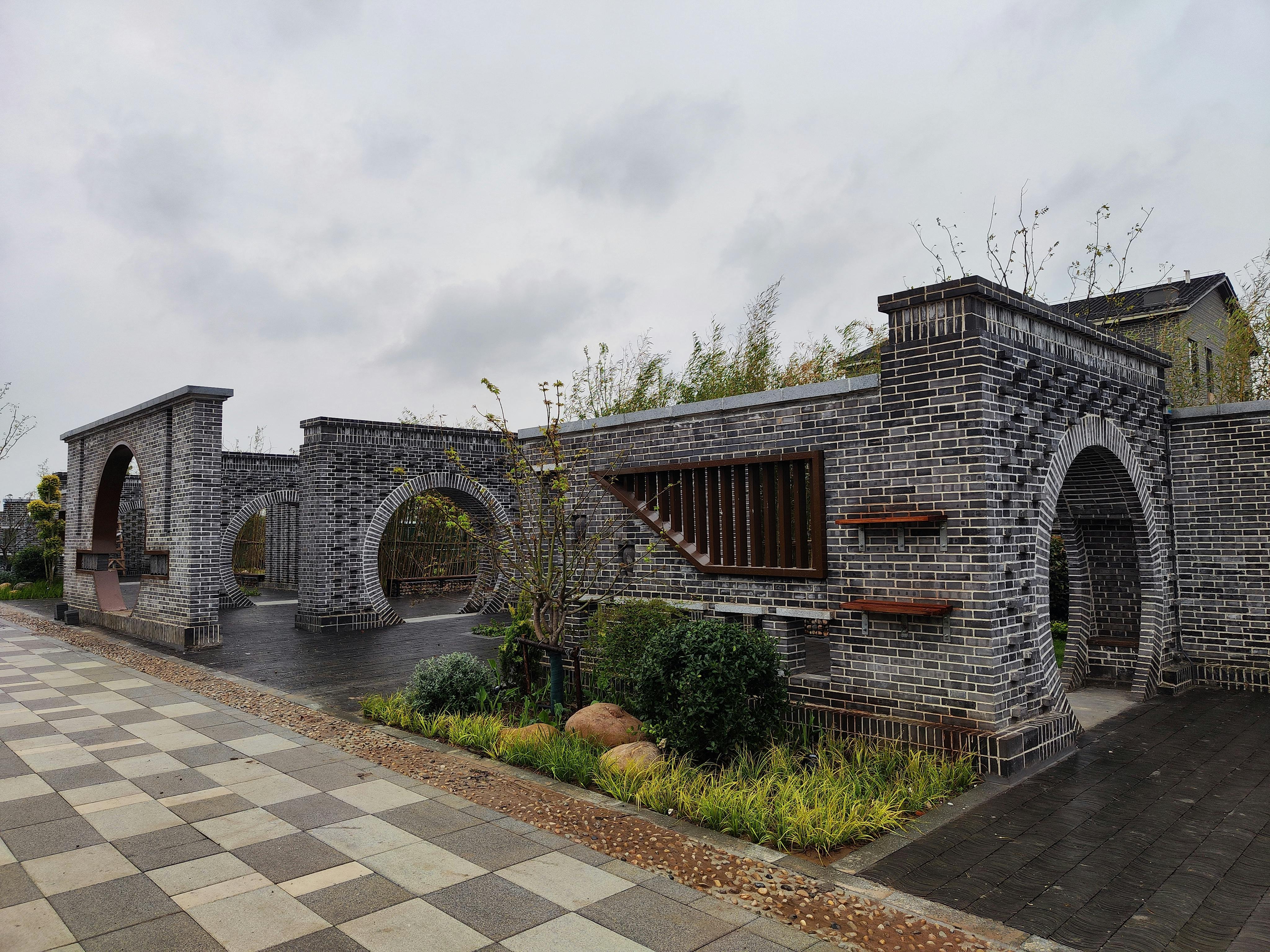 Elegant Brick Archways in Serene Garden Setting · Free Stock Photo