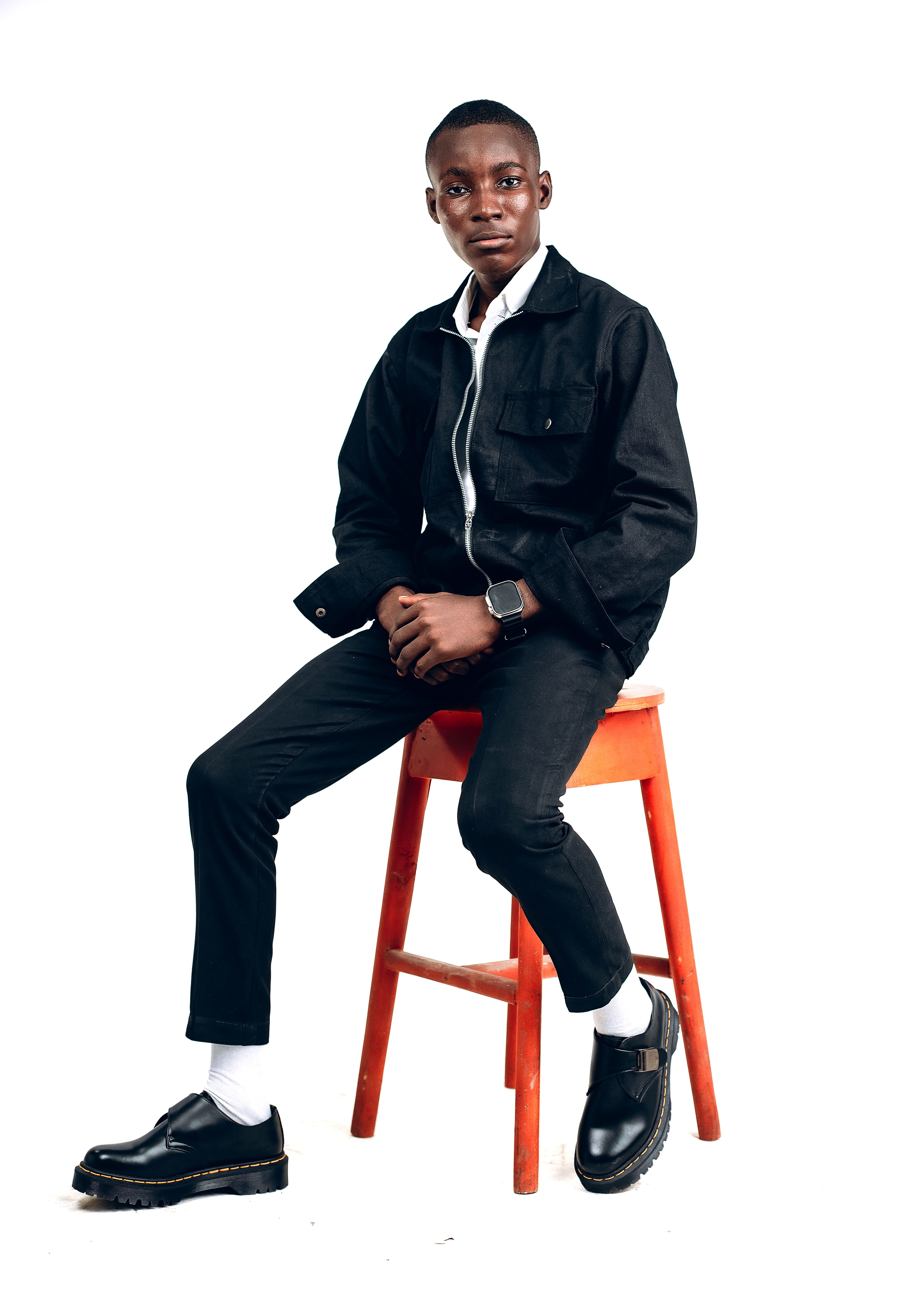 Stylish man seated on a vibrant stool in studio · Free Stock Photo