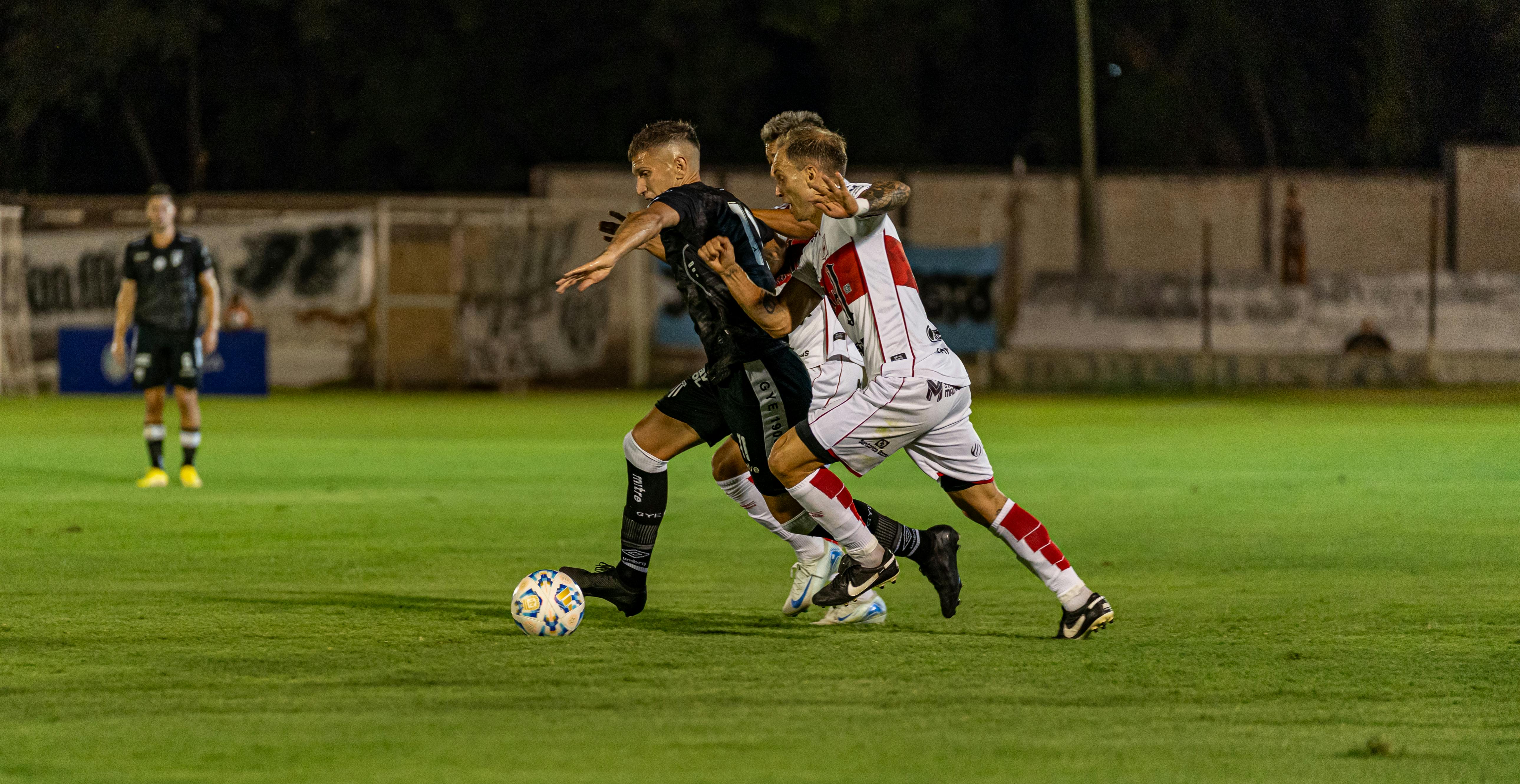 Intense Soccer Game Action at Night · Free Stock Photo