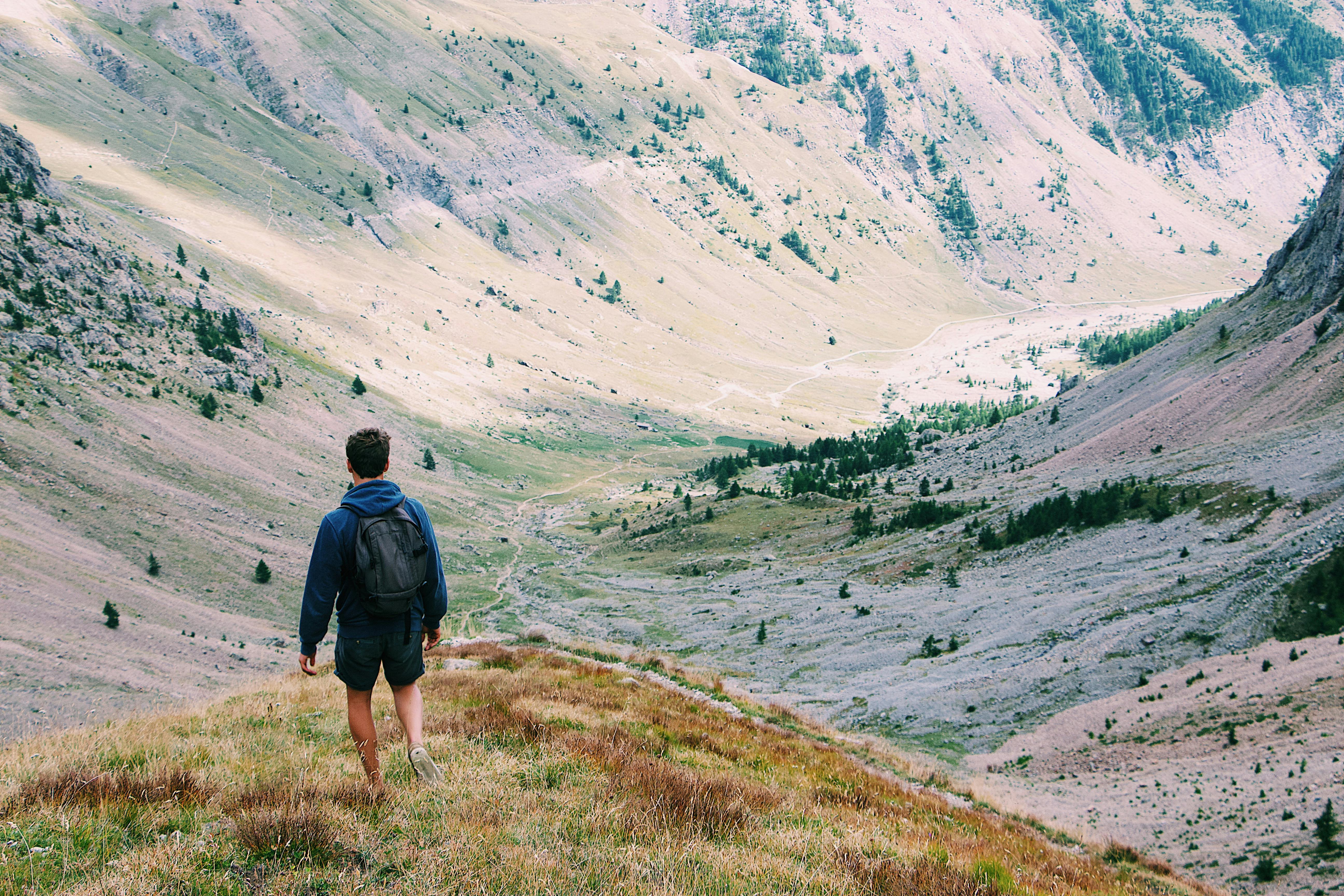 Man walking between mountains · Free Stock Photo