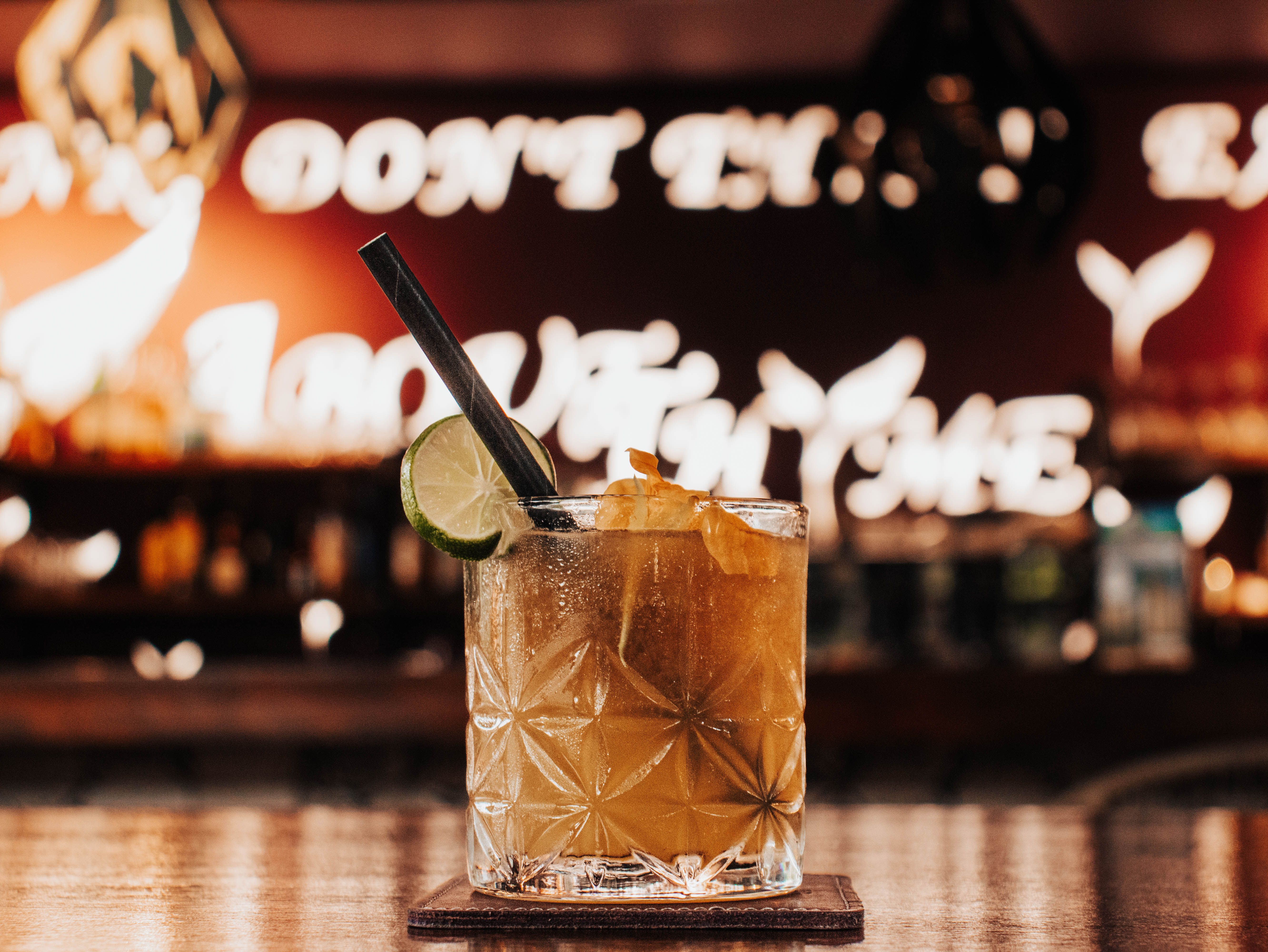 Elegant Cocktail with Lime in Dimly Lit Bar · Free Stock Photo