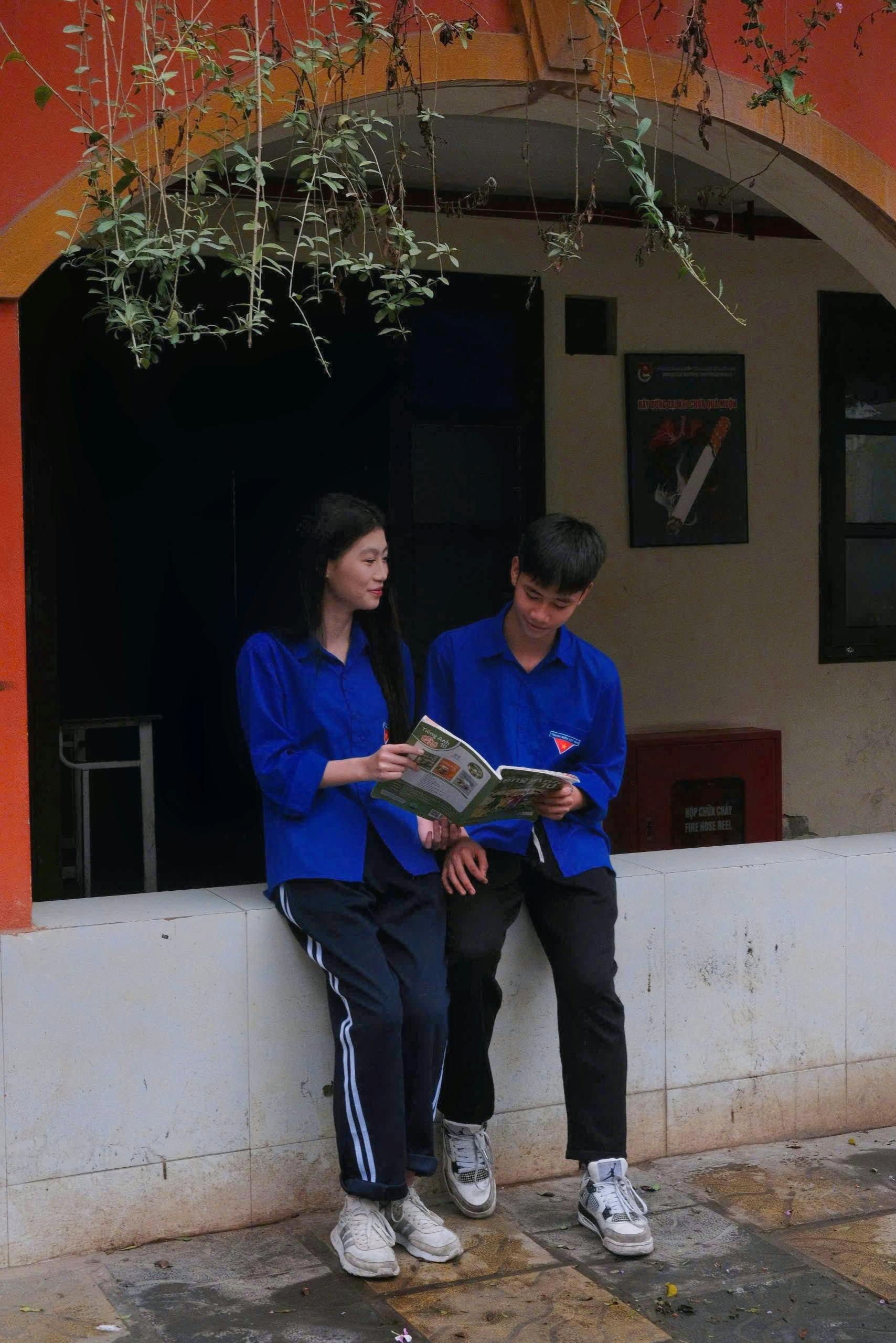 Students Reading on School Campus in Blue Uniforms · Free Stock Photo