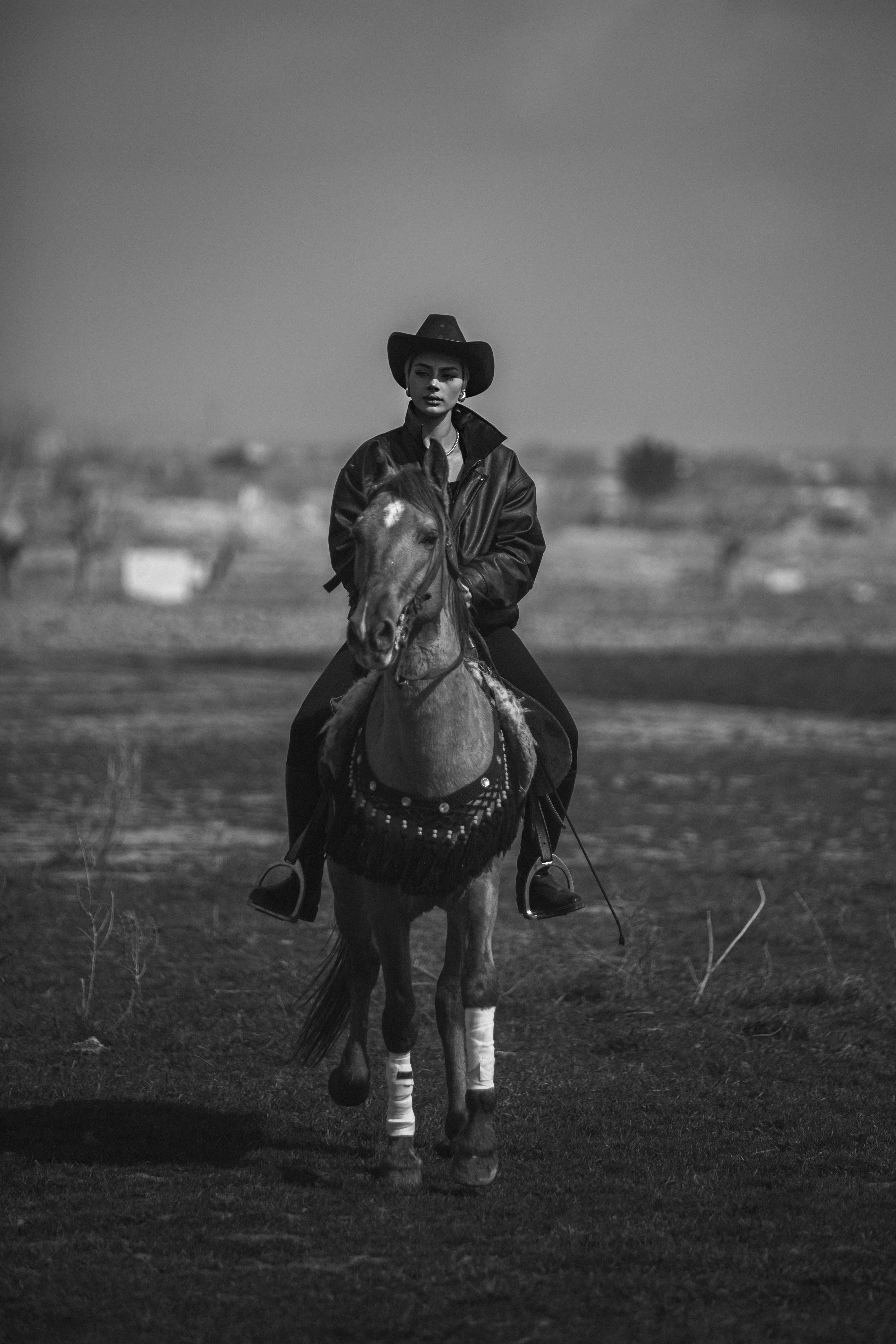 Black and White Cowboy Riding in Open Field · Free Stock Photo