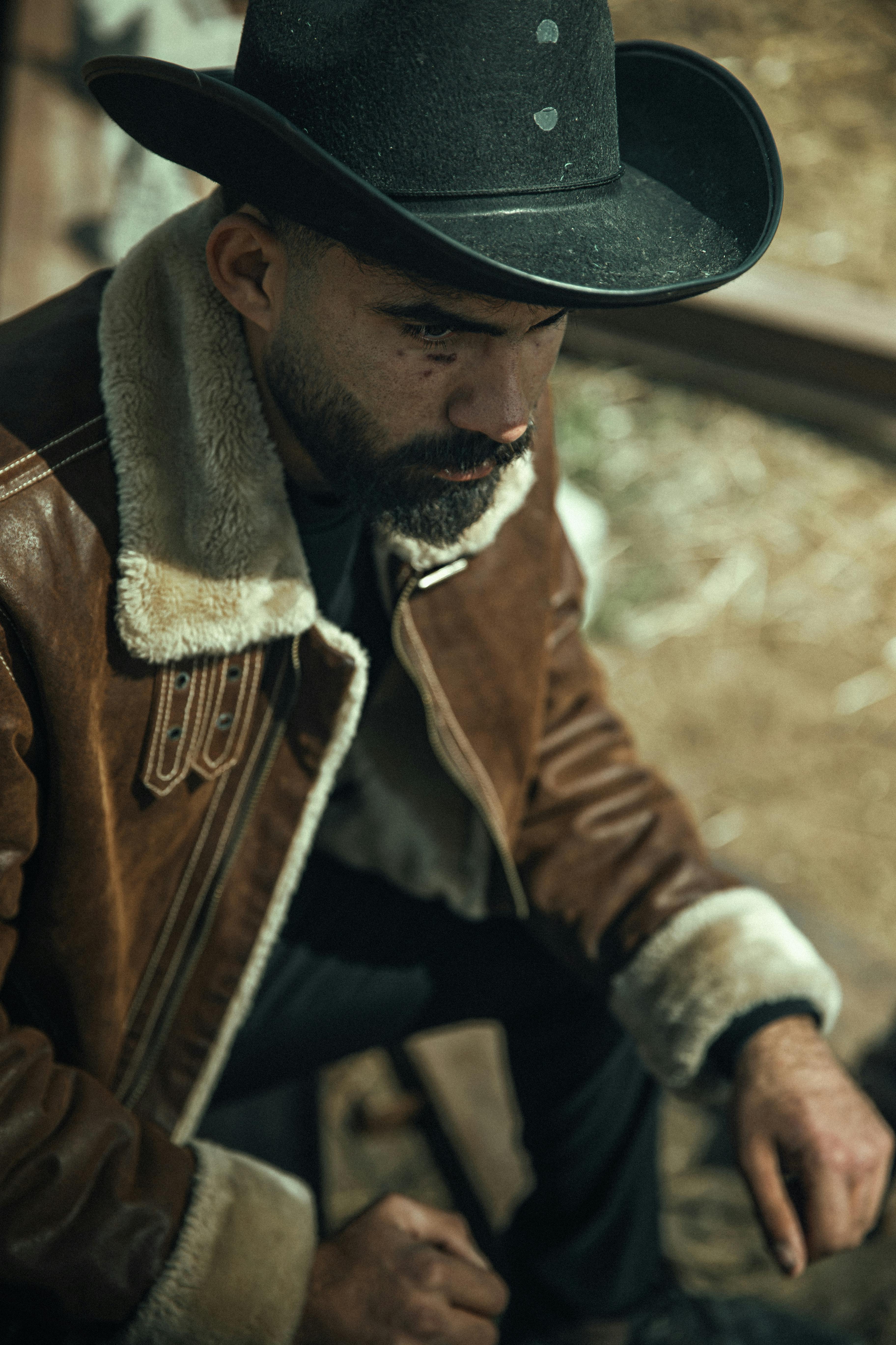 Pensive Cowboy in Vintage Shearling Jacket Outdoors · Free Stock Photo