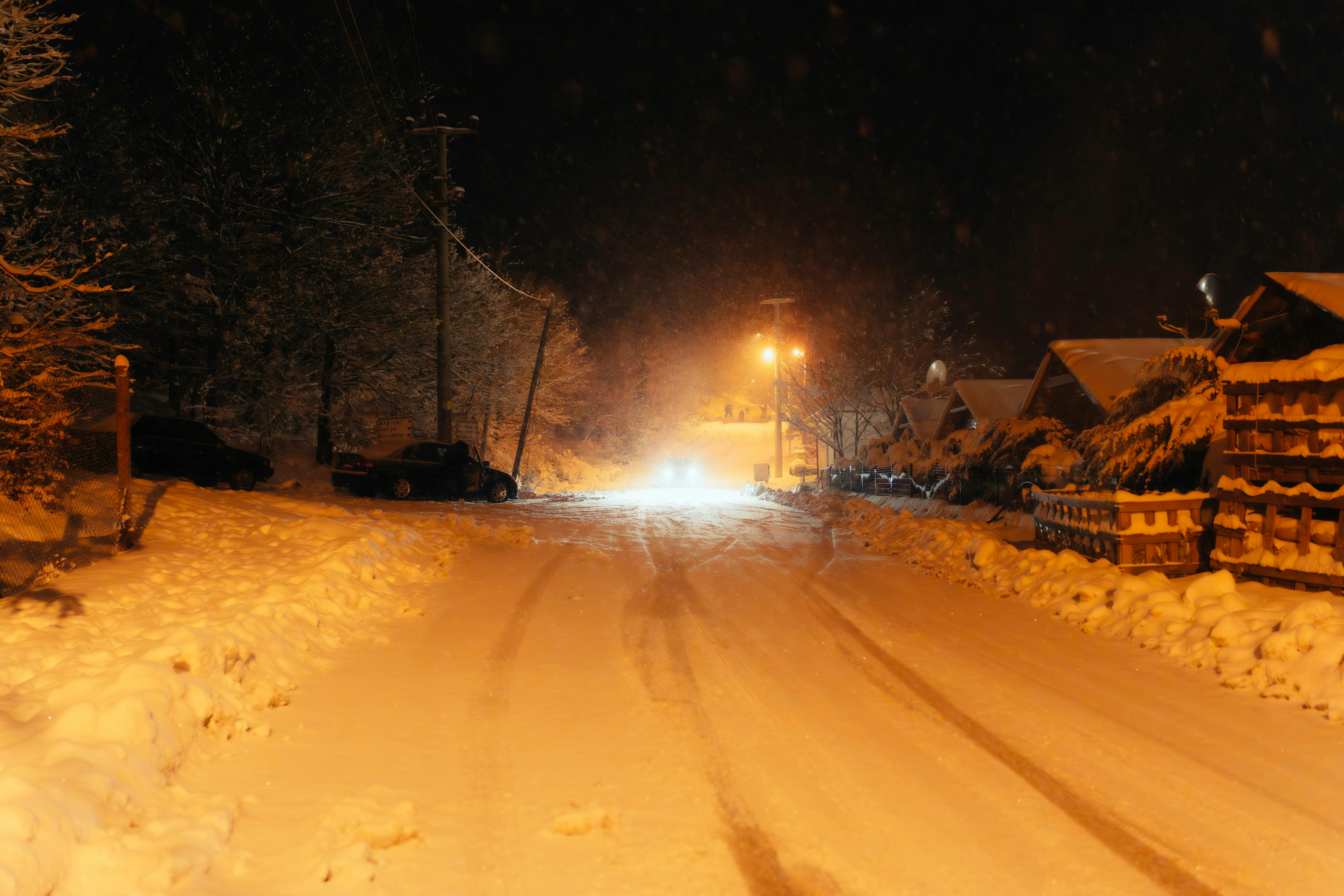 Snowy Winter Night on Illuminated Street · Free Stock Photo